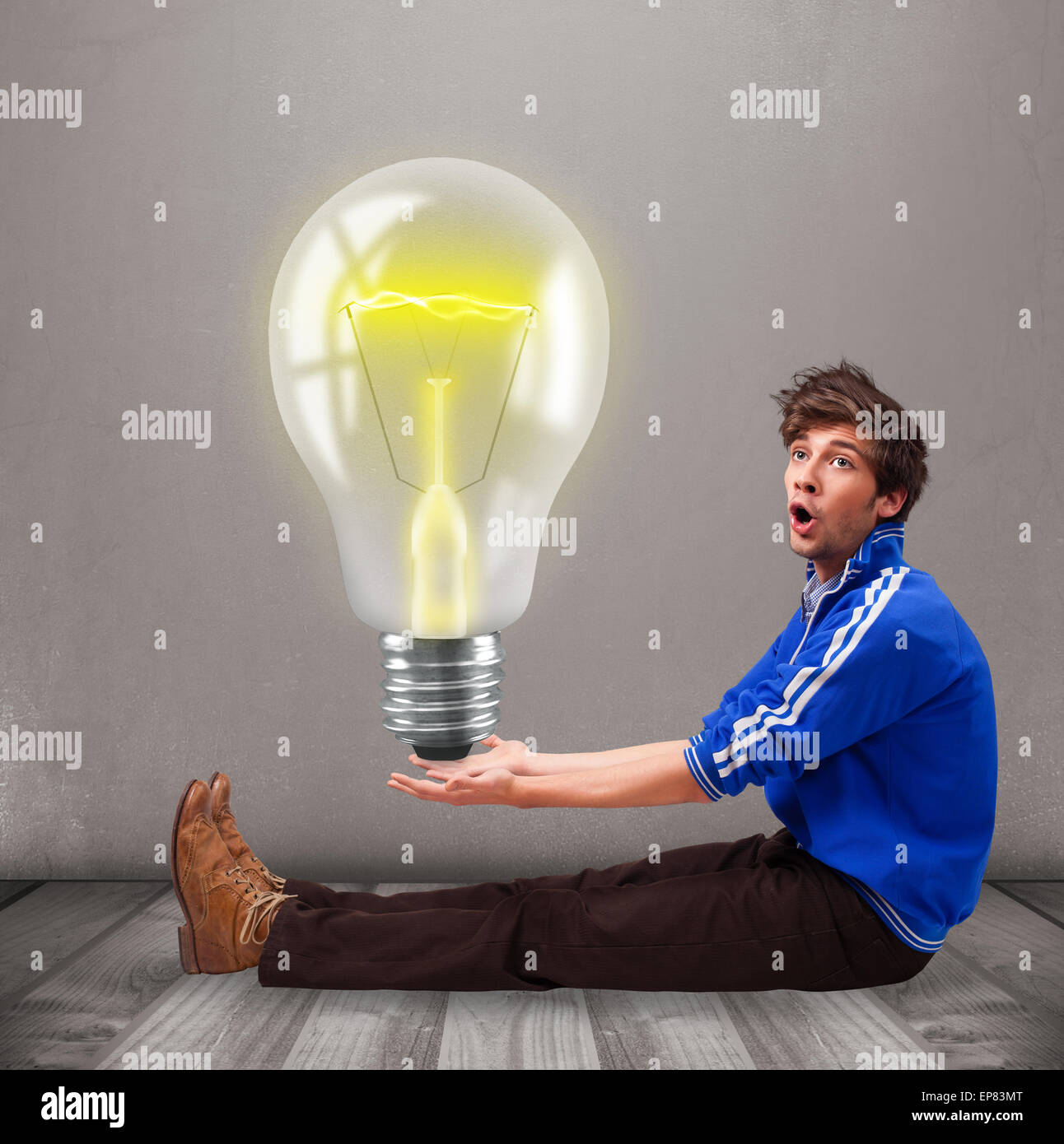 Attractive man holding realistic 3d light bulb Stock Photo - Alamy