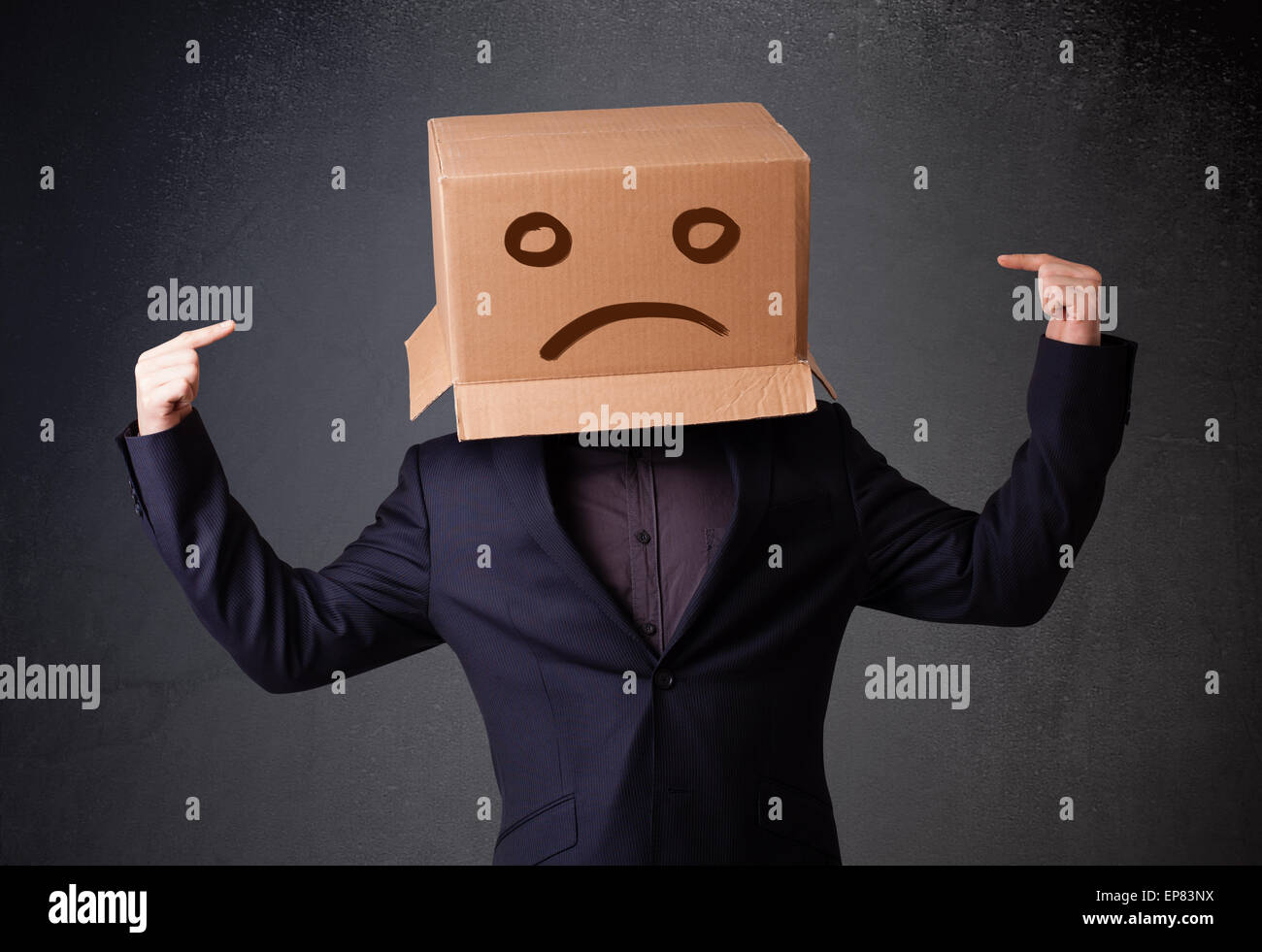 Young man with a brown cardboard box on his head with sad face Stock ...