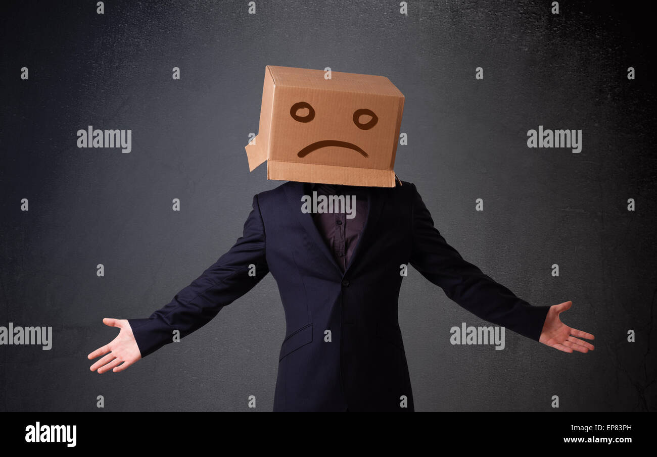 Young man with a brown cardboard box on his head with sad face Stock ...