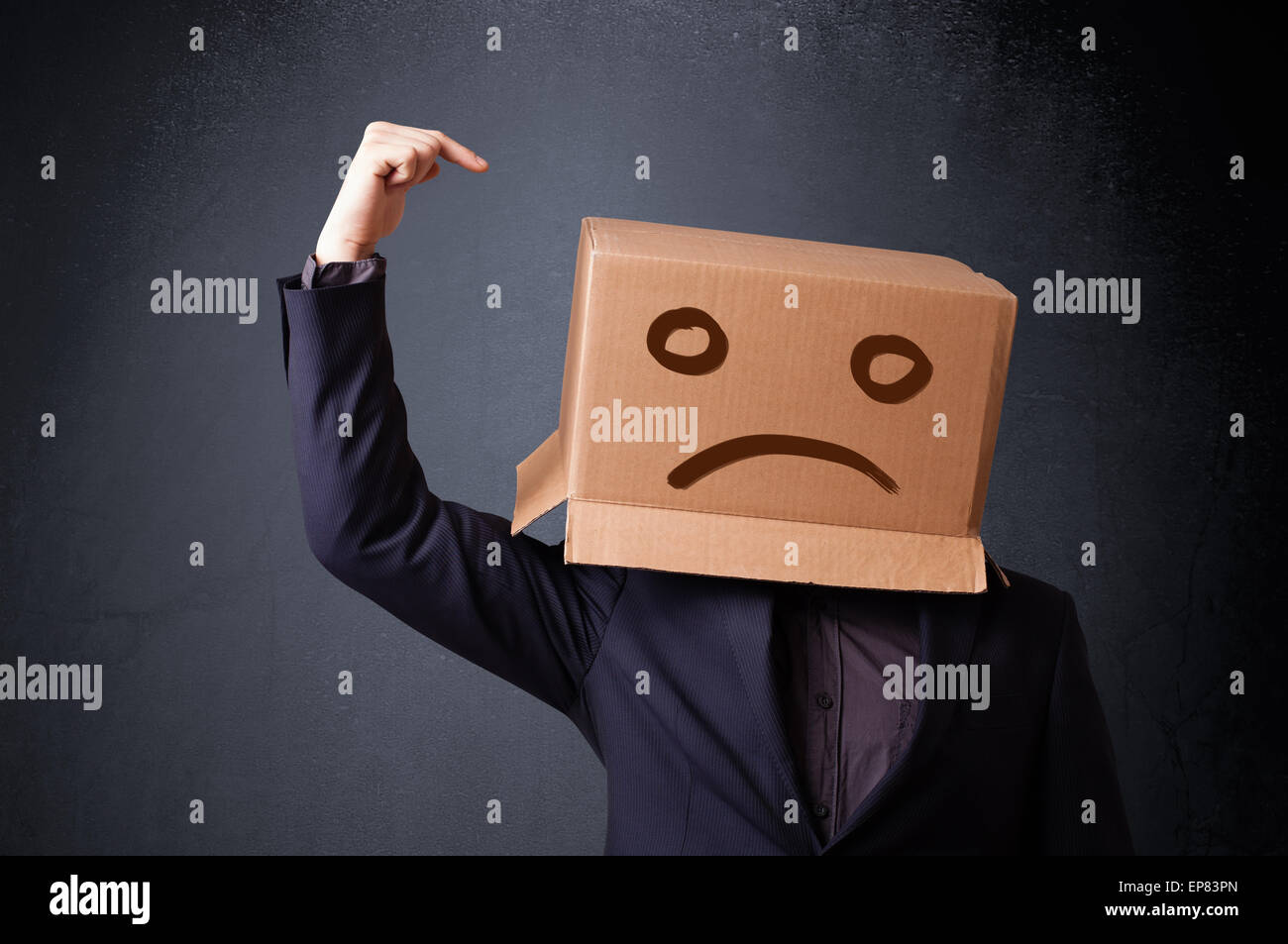 Young man with a brown cardboard box on his head with sad face Stock ...