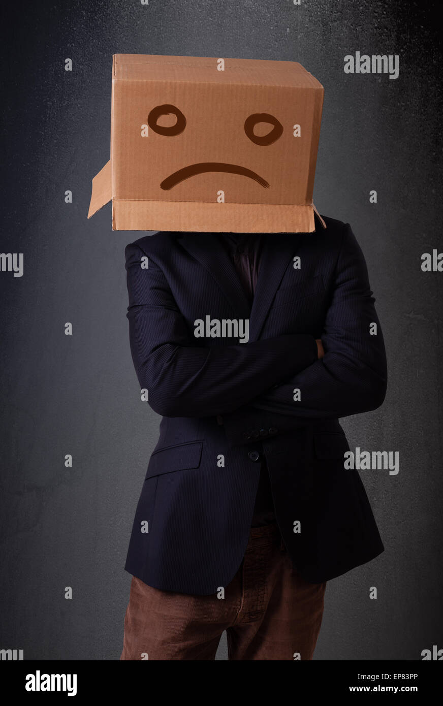 Young man with a brown cardboard box on his head with sad face Stock ...