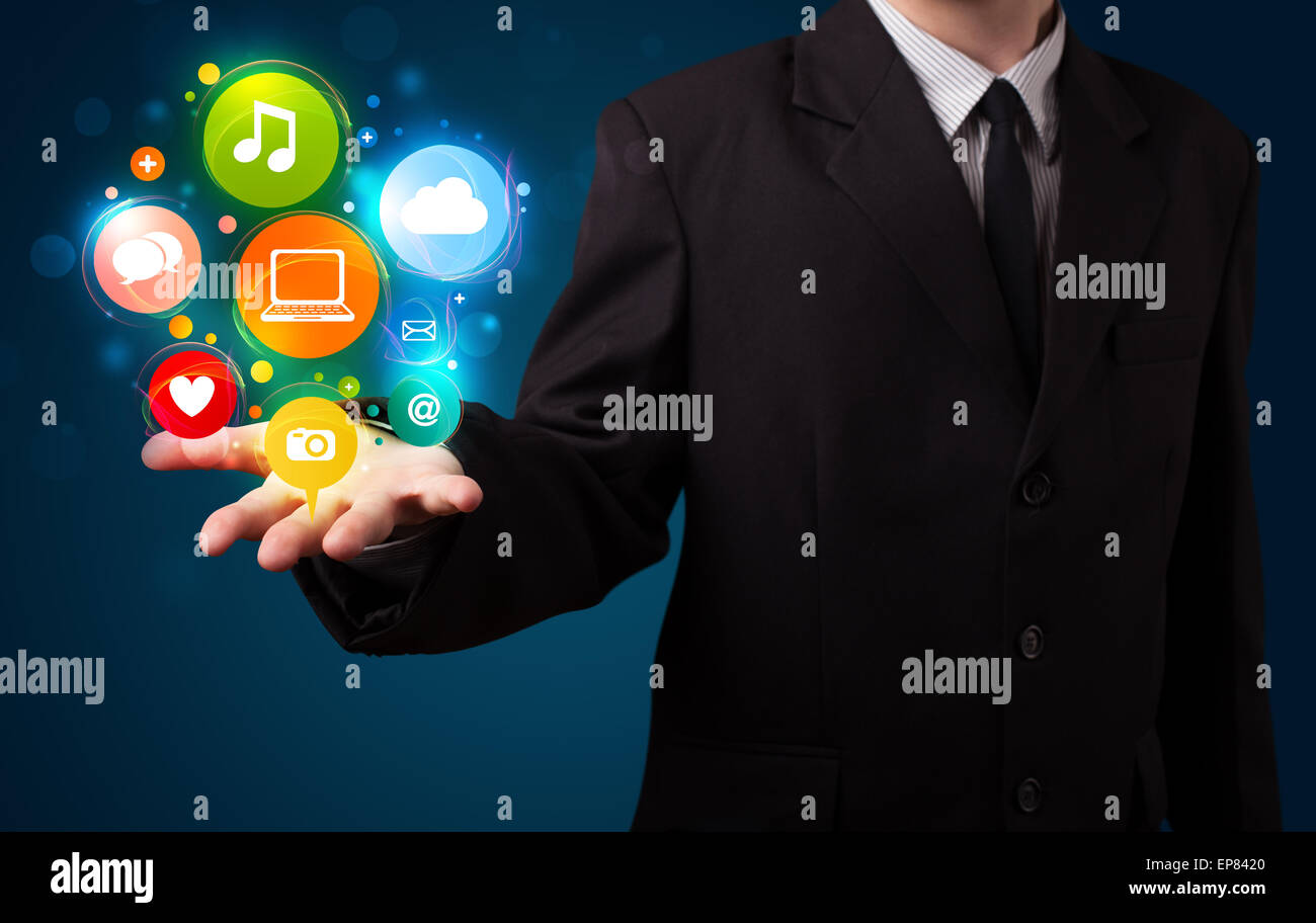 Young businessman presenting colorful technology icons and symbols ...