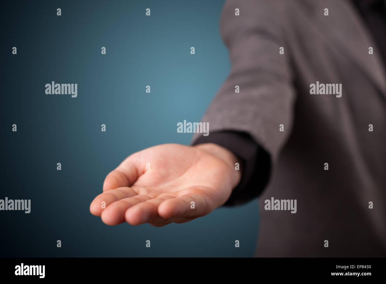 Handsome business man presenting with hand copy space Stock Photo - Alamy