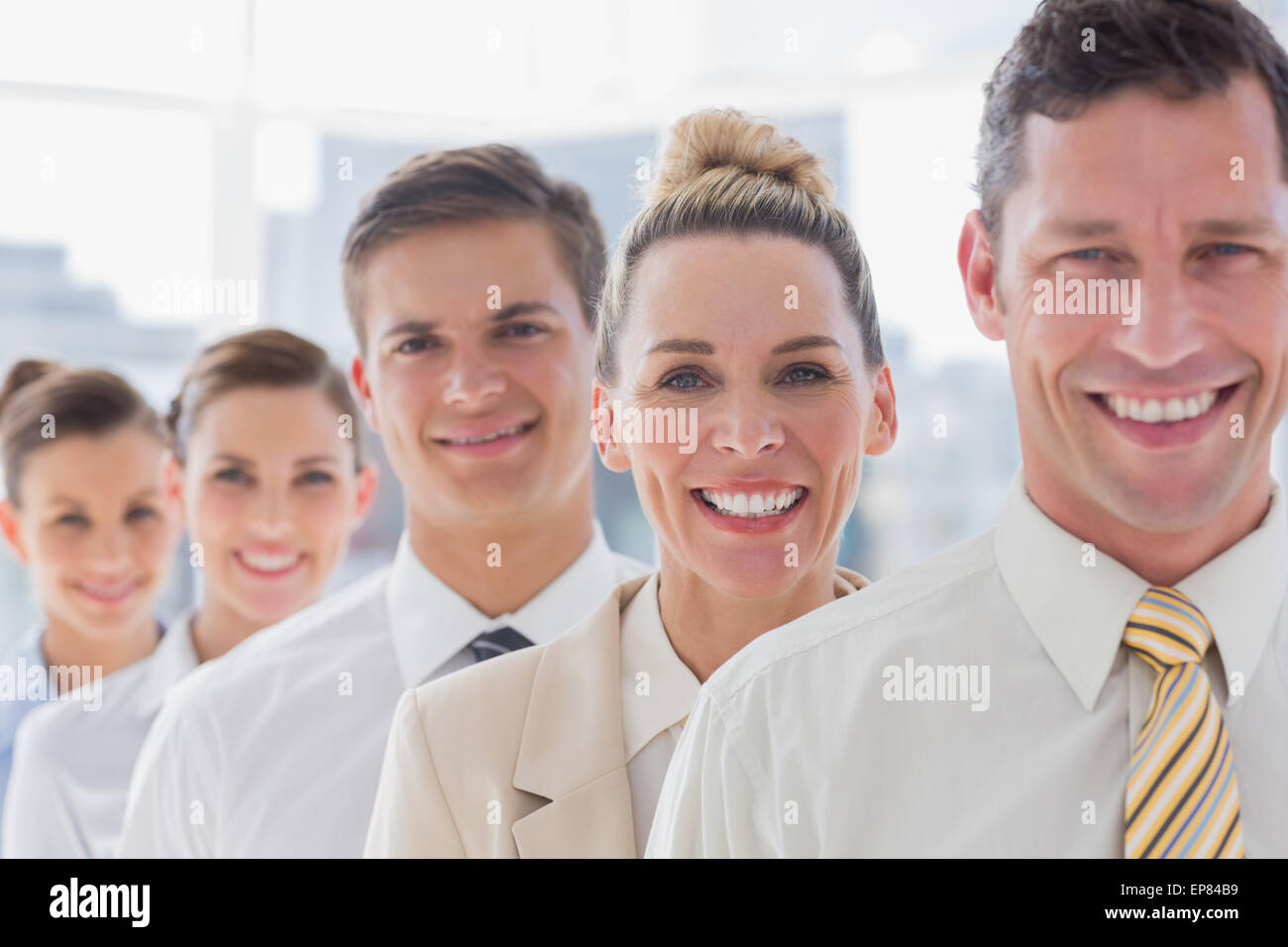 Smiling handsome businessman standing with his team Stock Photo - Alamy