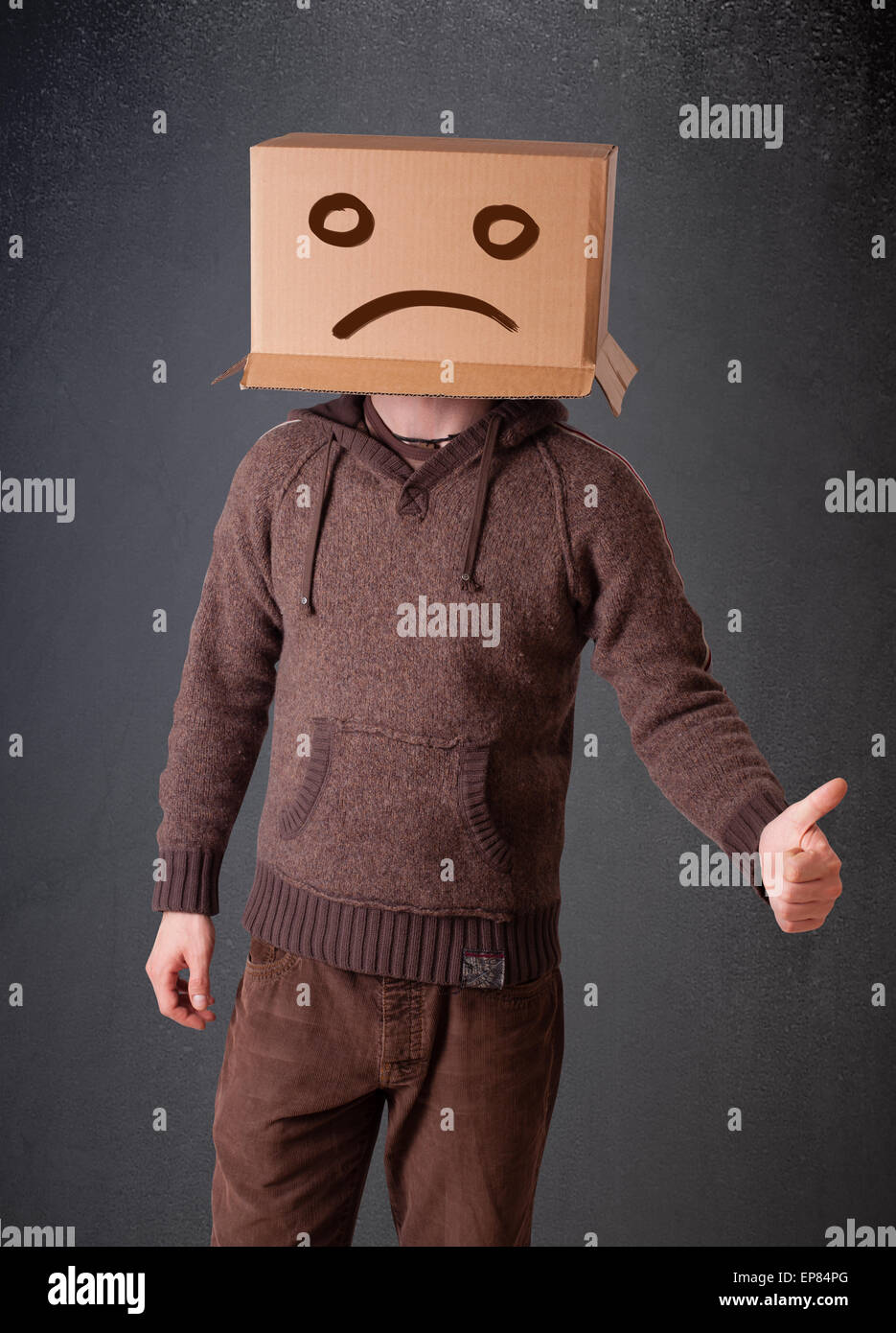 Young man with a brown cardboard box on his head with sad face Stock ...