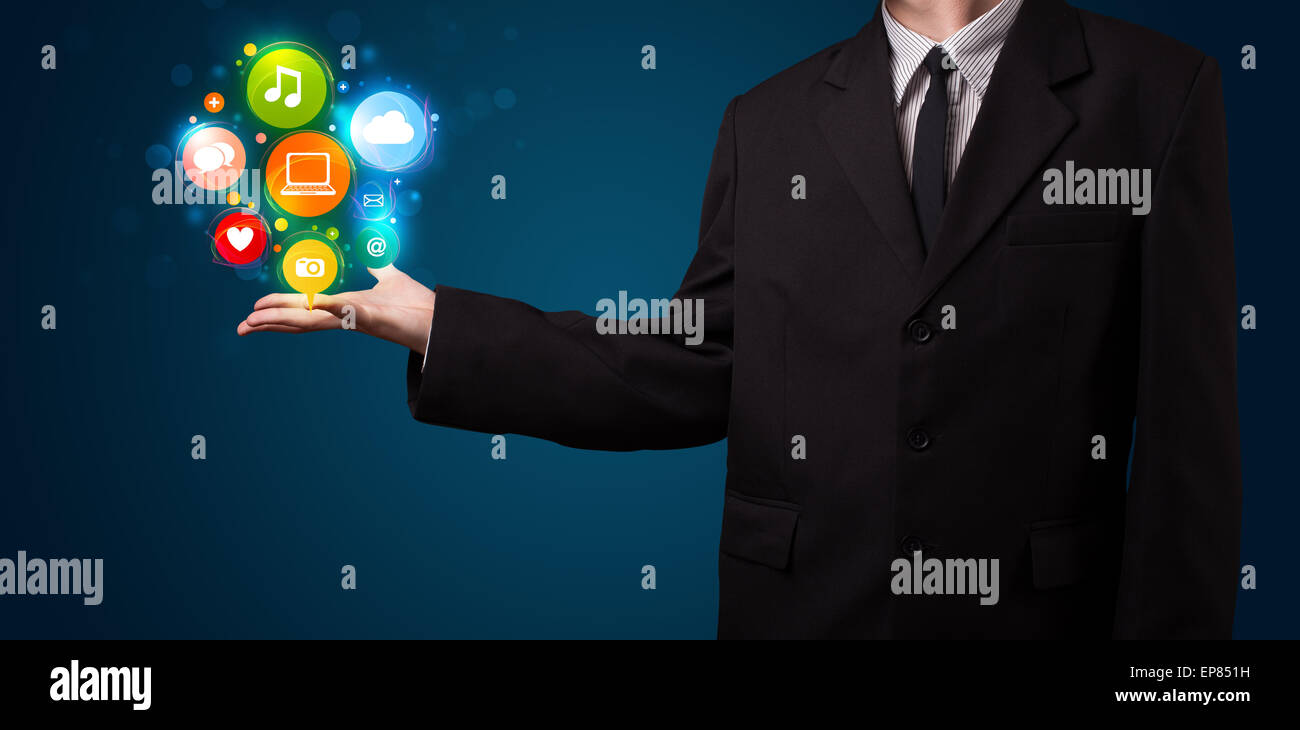Young businessman presenting colorful technology icons and symbols ...