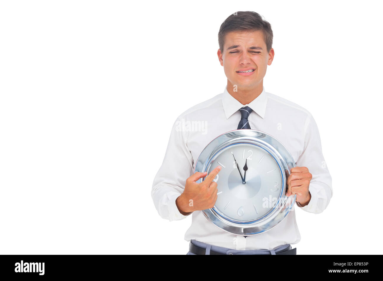 Worried businessman holding and pointing at clock Stock Photo - Alamy