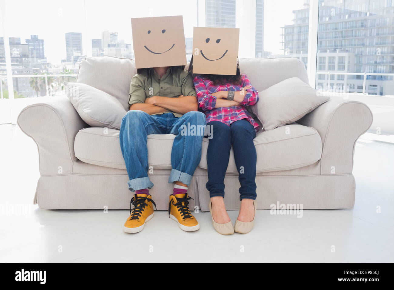 Silly employees with arms folded wearing boxes on their heads Stock ...