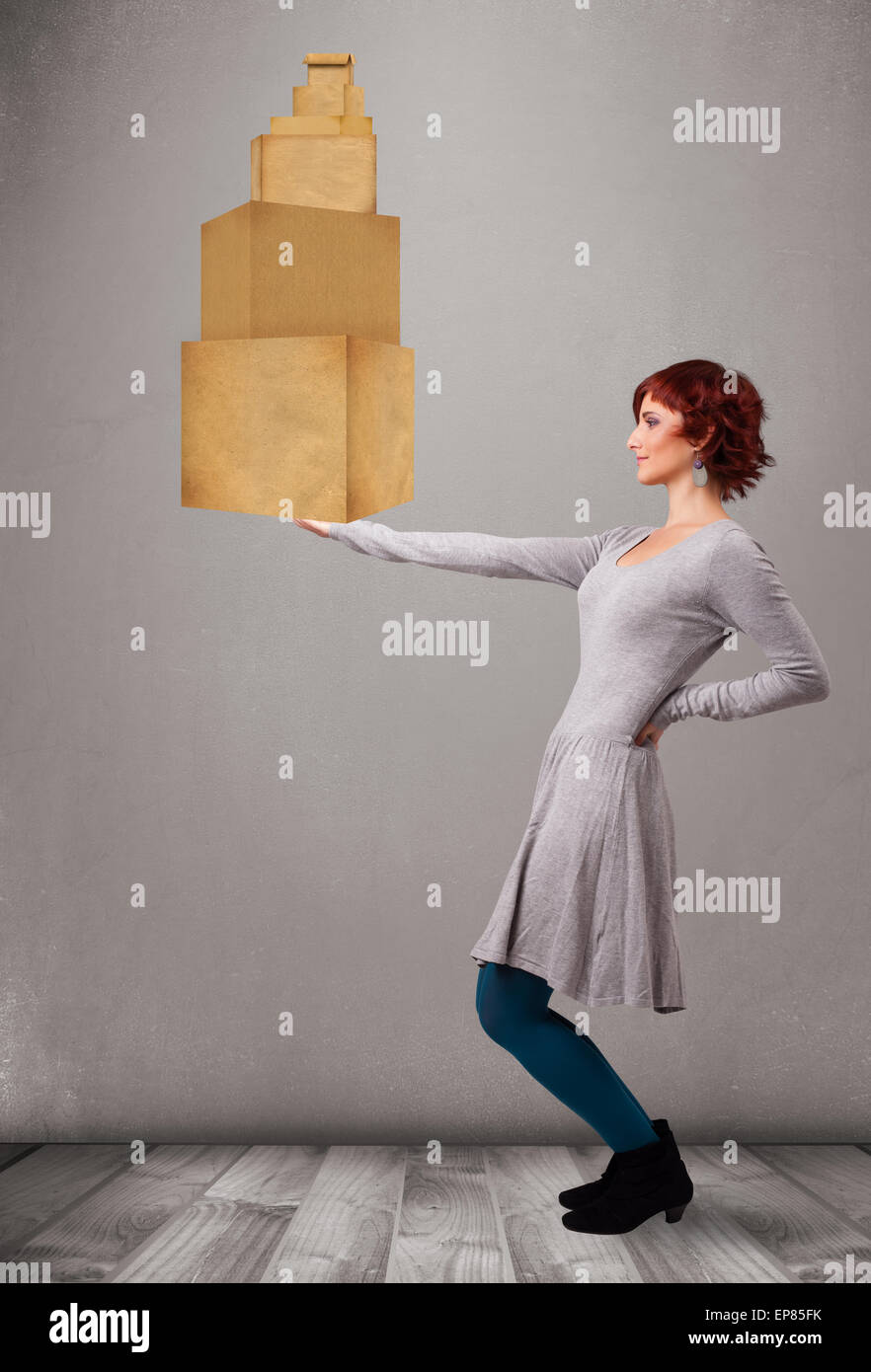 Young lady holding a set of brown cardboard boxes Stock Photo - Alamy