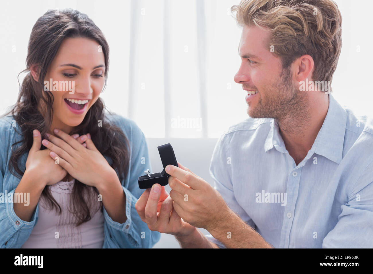 Man offering an engagement ring to his partner Stock Photo - Alamy