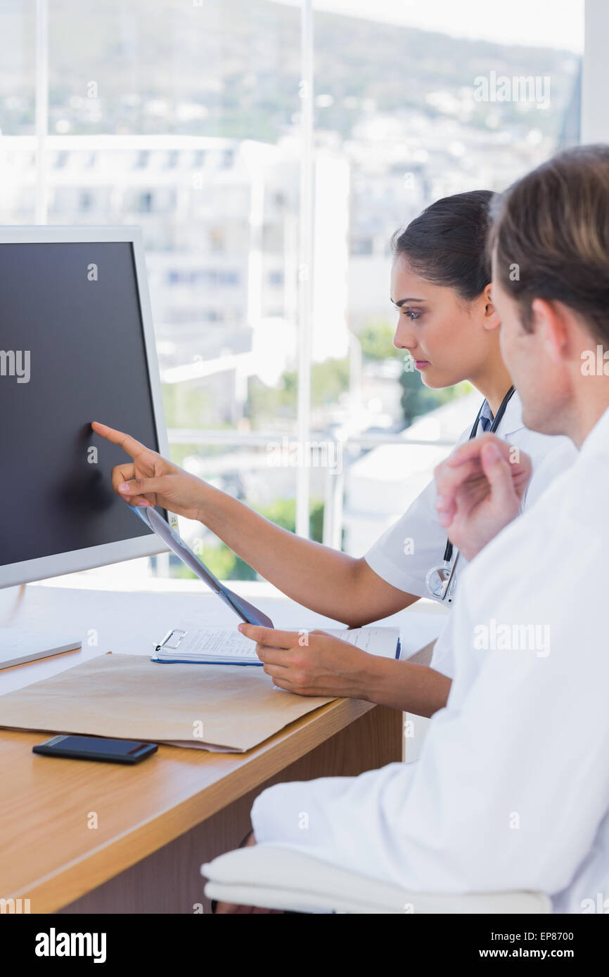 Beautiful nurse showing the screen of a computer to a colleague Stock ...