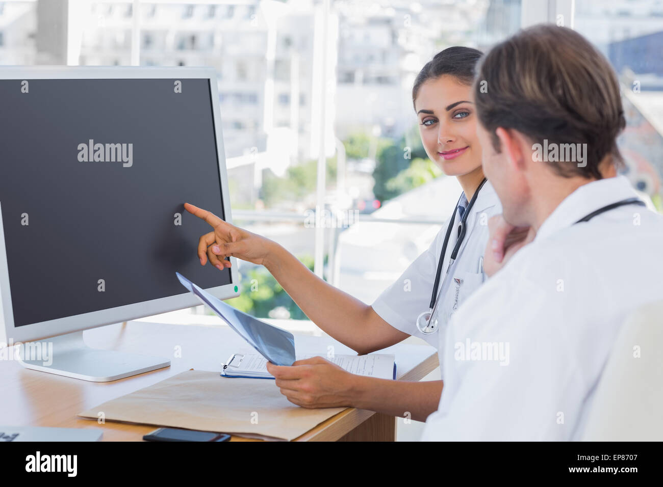 Doctor showing the screen of a computer to a colleague Stock Photo - Alamy
