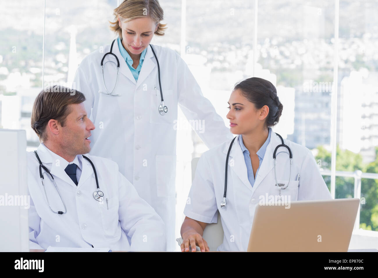 Group of doctors discussing and working together Stock Photo - Alamy