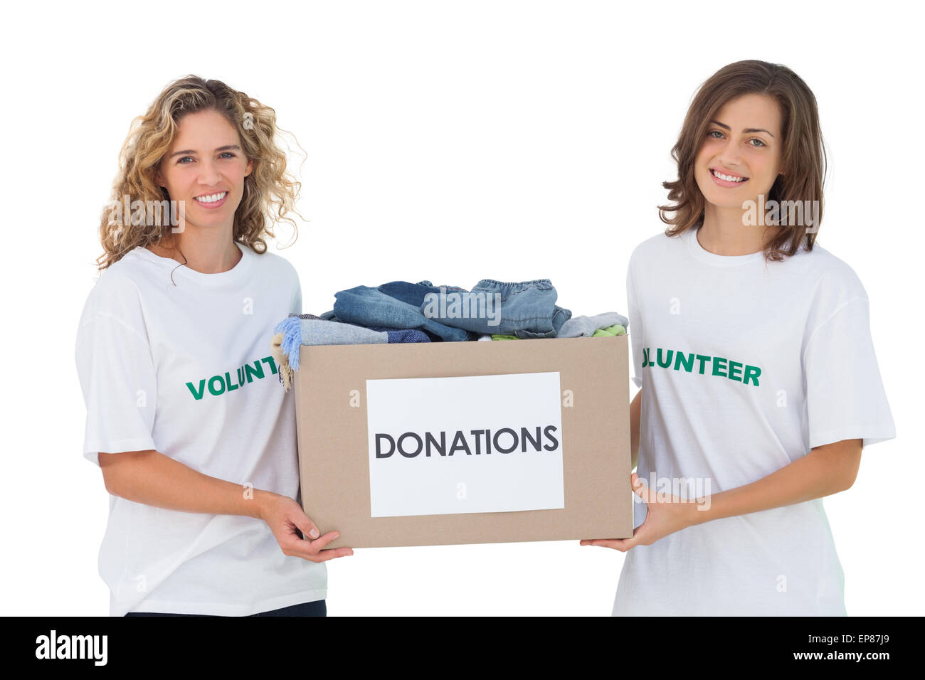 Two cheerful volunteers carrying clothes donation box Stock Photo - Alamy