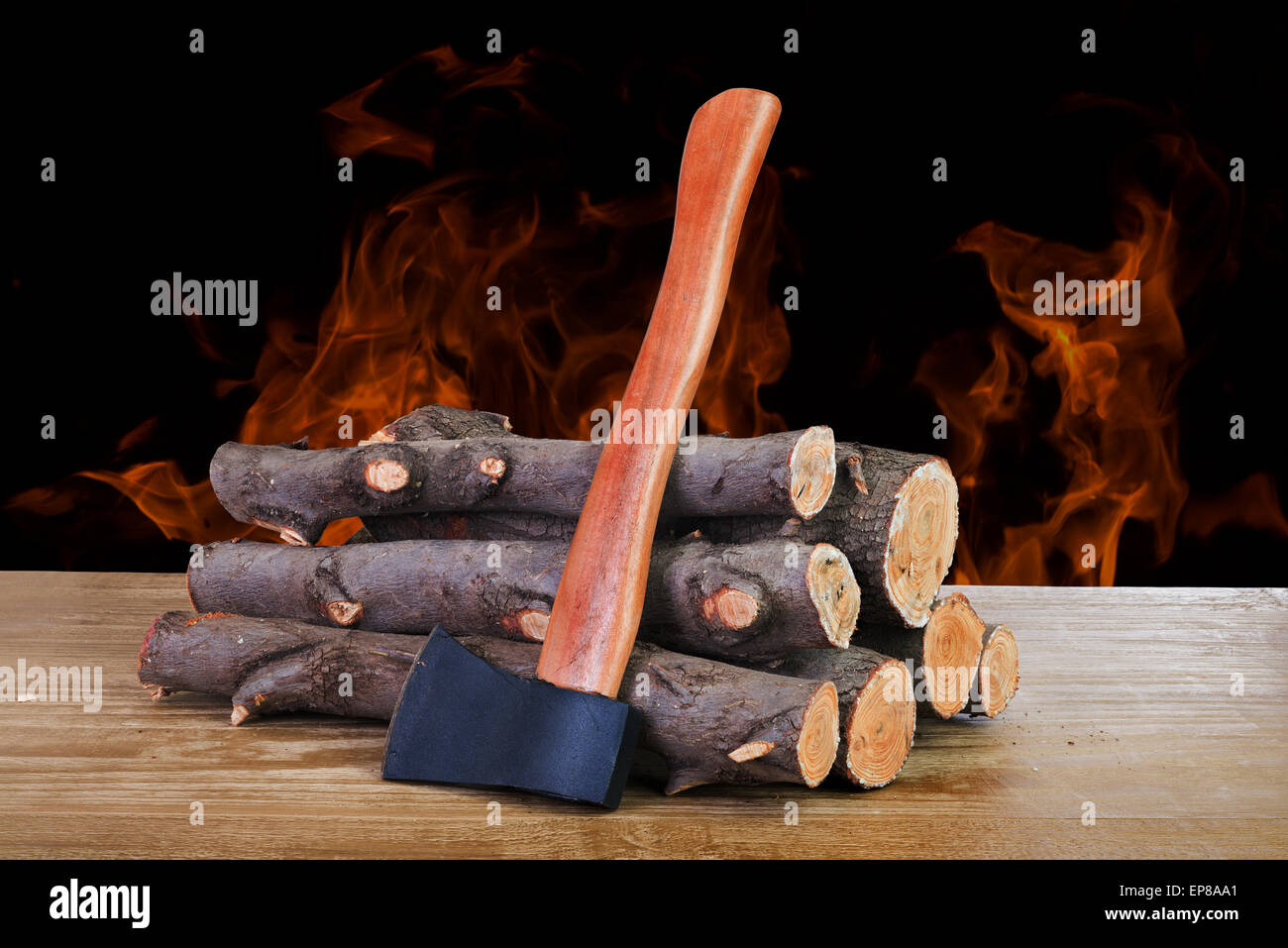 stack of firewood logs and axe on a wooden surface Stock Photo - Alamy