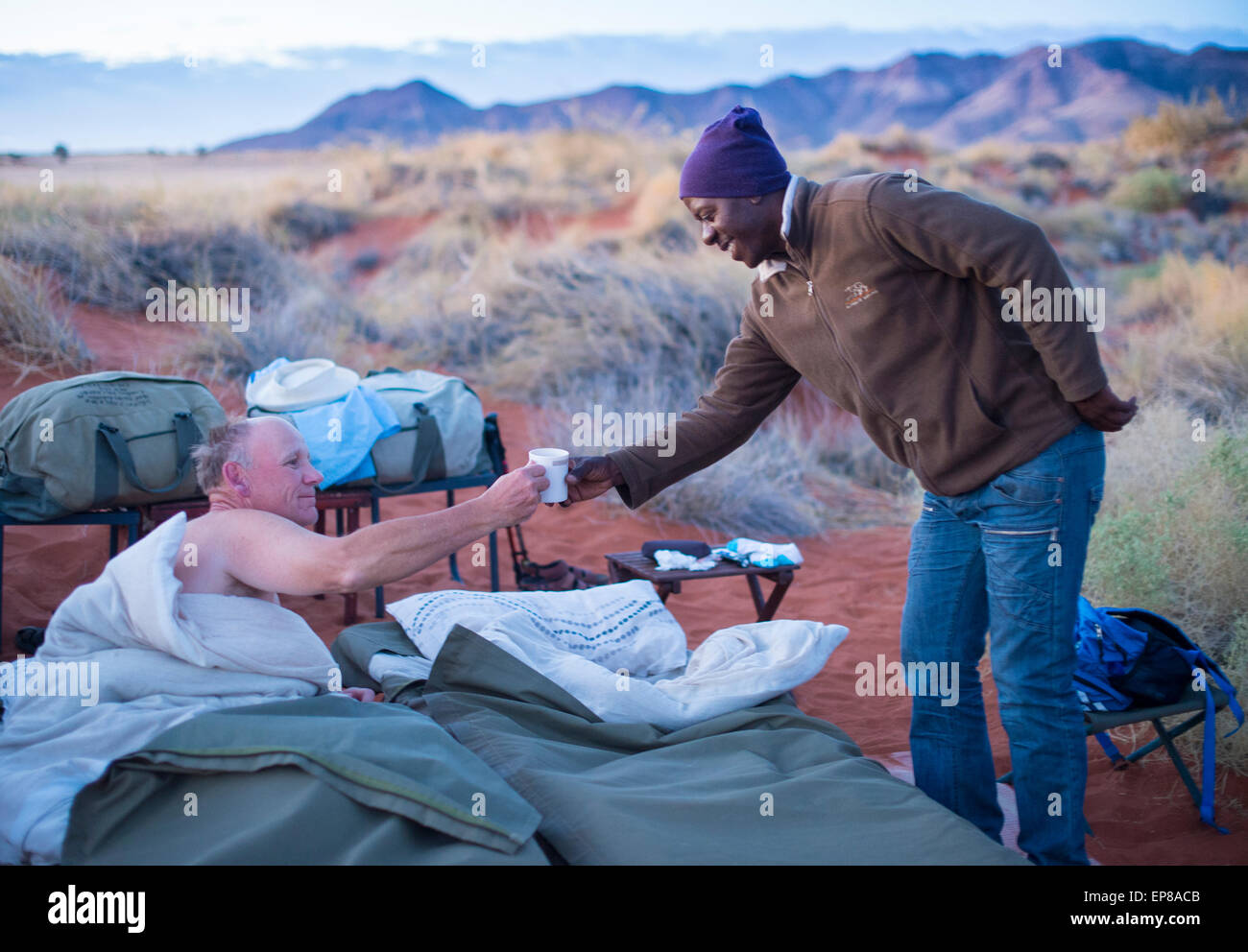 Africa, Namibia. Tok Tokkie Trails. Coffee in bed being served Stock ...