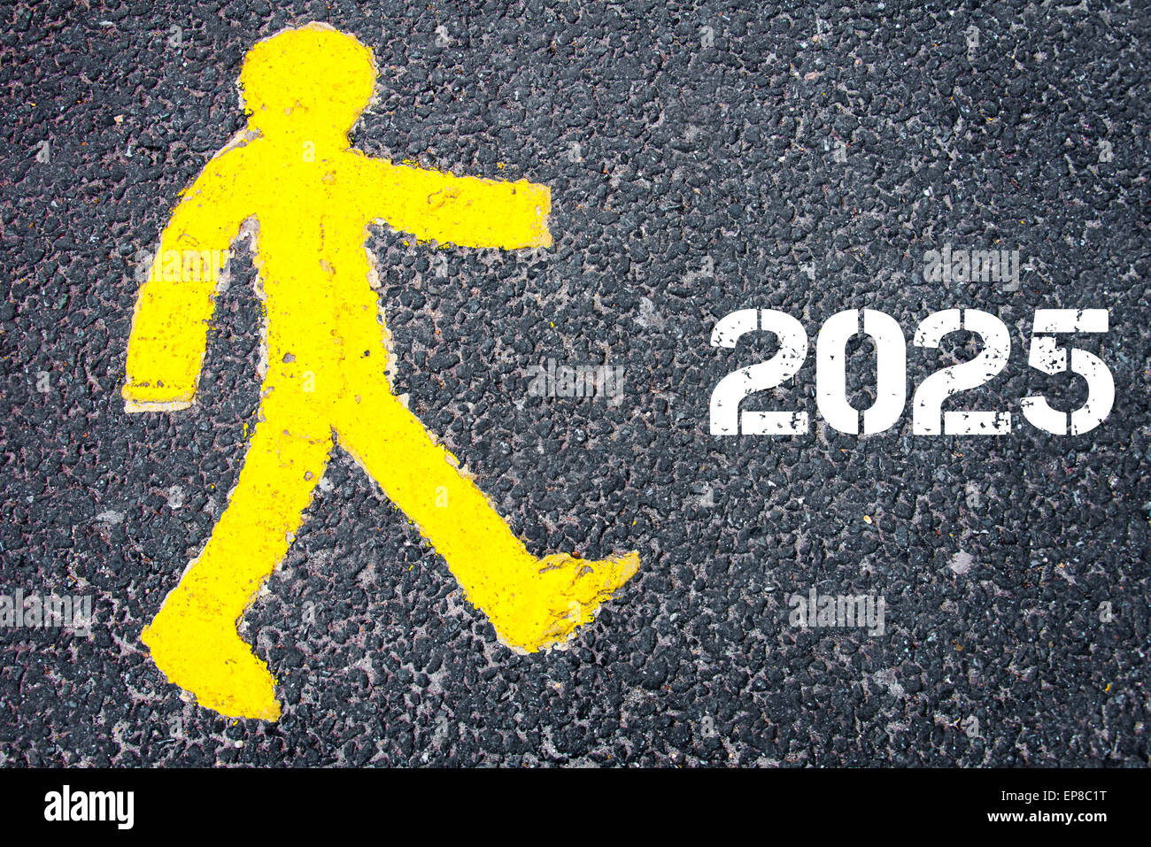 Yellow pedestrian figure on the road walking towards YEAR 2025 ...