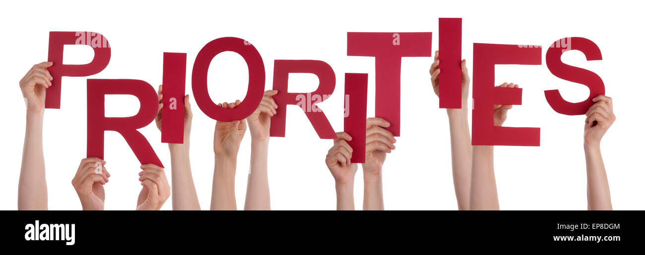 Many People Hands Holding Red Word Priorities Stock Photo - Alamy