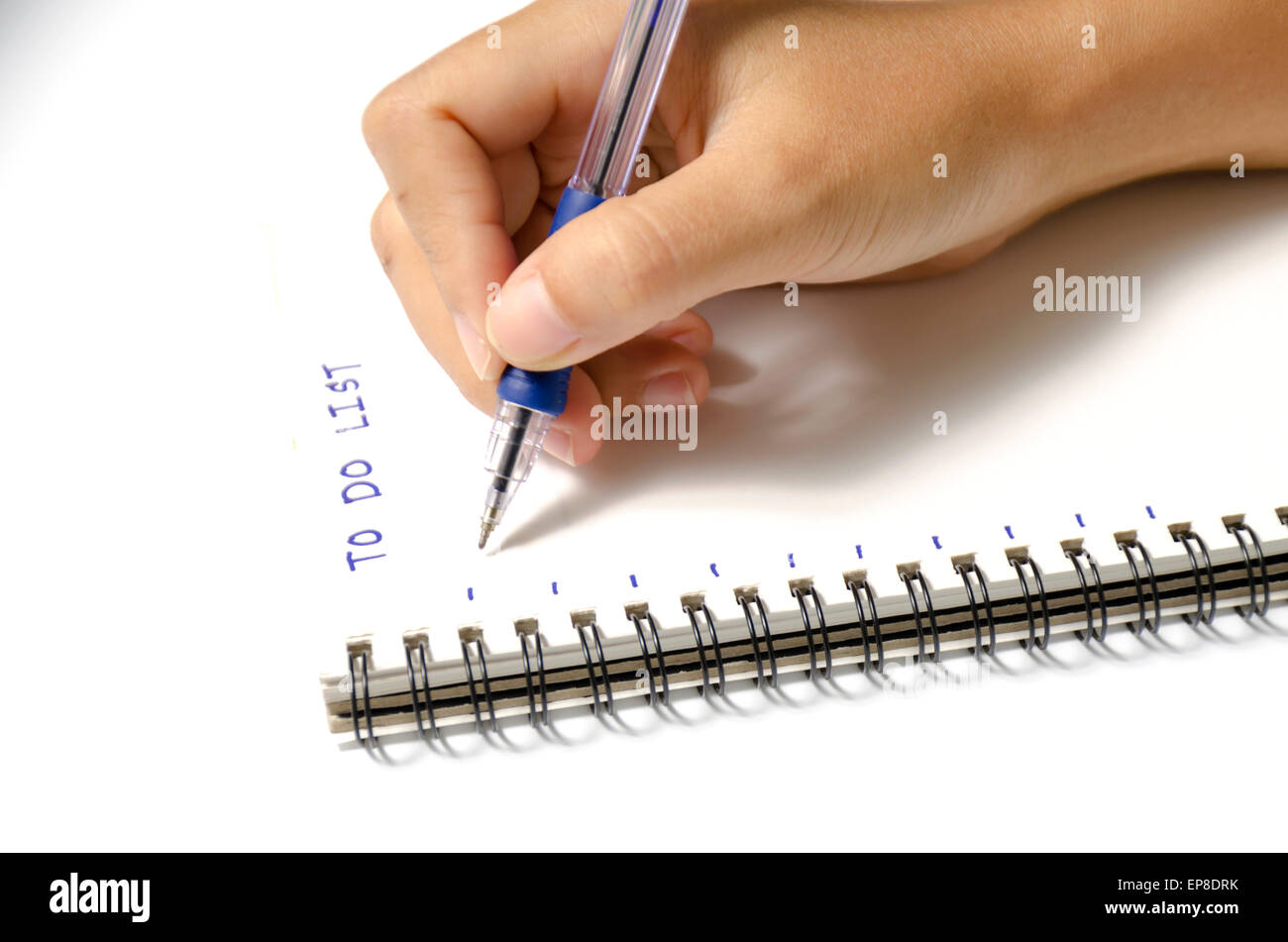 woman hand writing with pen on notebook write to do word over white ...