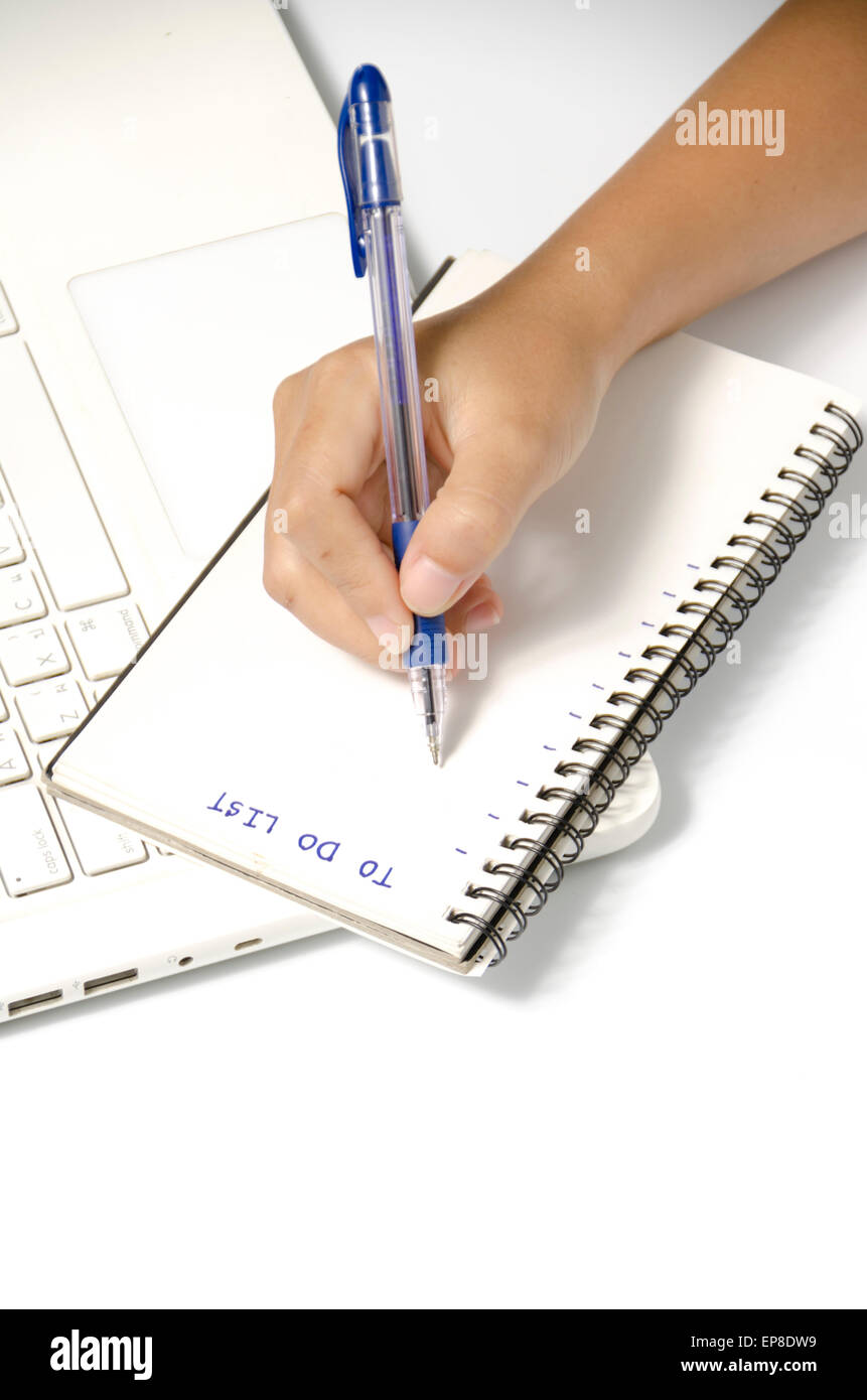 woman hand writing with pen on notebook write to do word and laptop ...