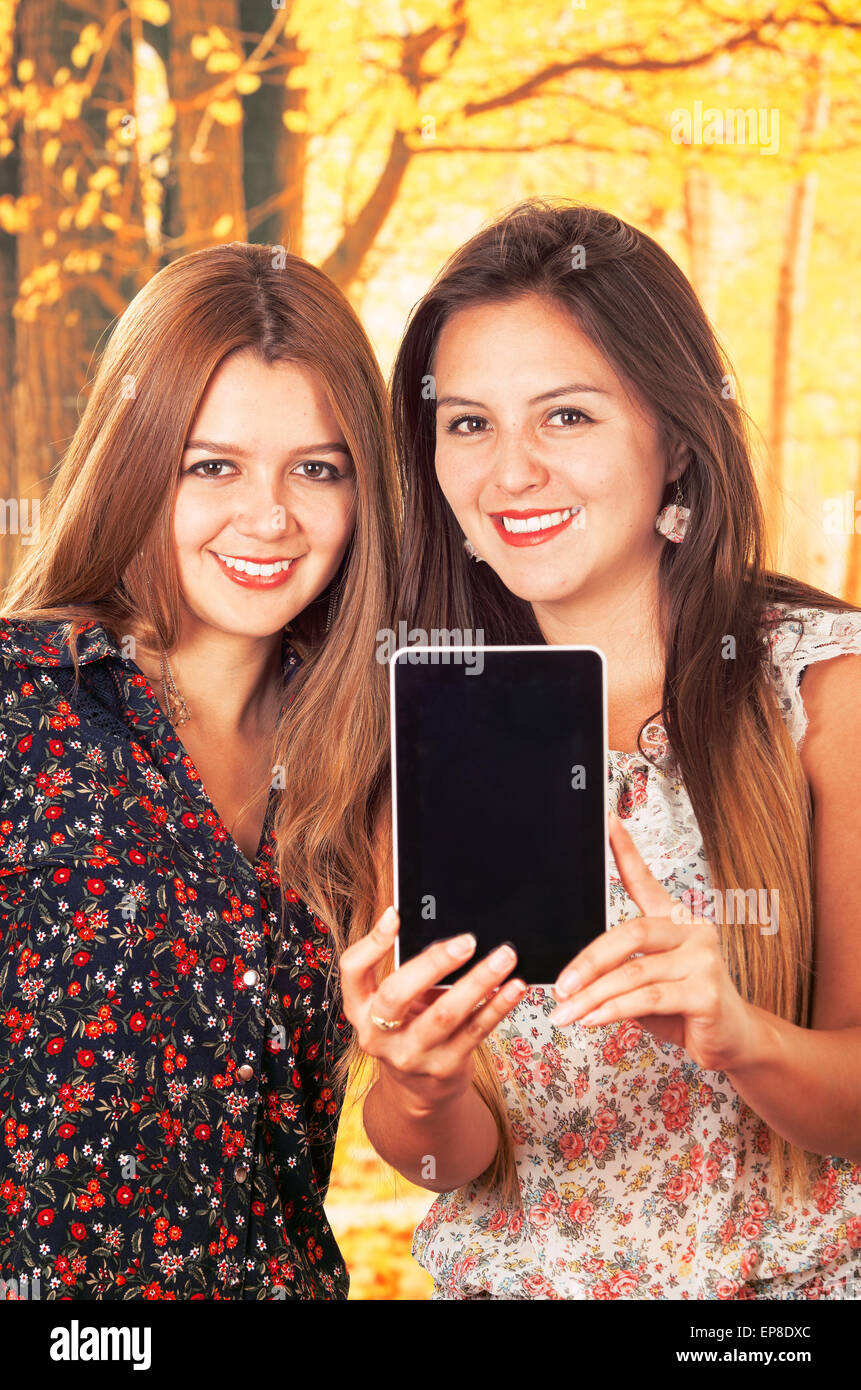 Beautiful young trendy girls using tablet Stock Photo - Alamy