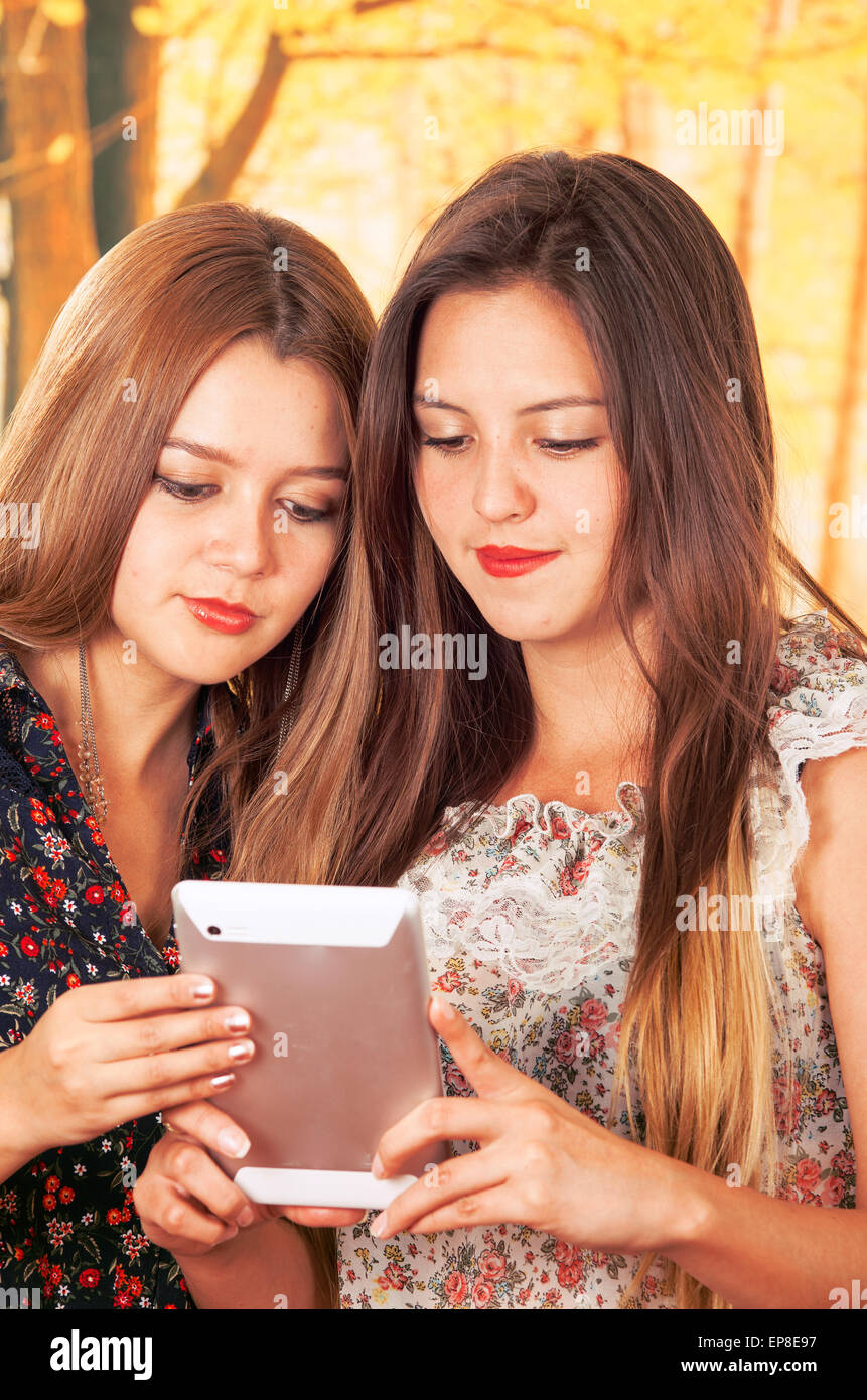 Beautiful young trendy girls using tablet Stock Photo - Alamy
