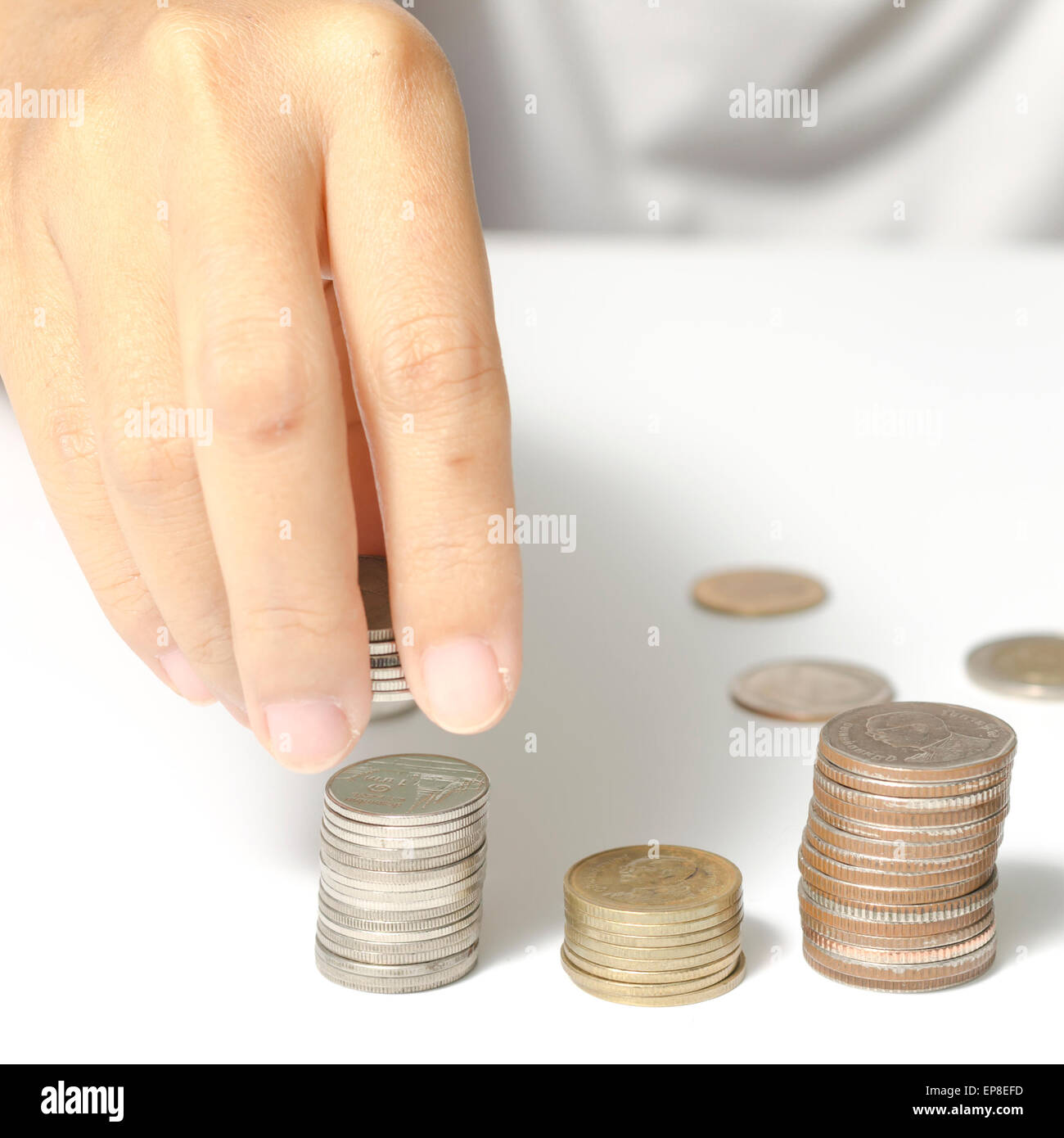woman hand putting stack of coins Stock Photo - Alamy