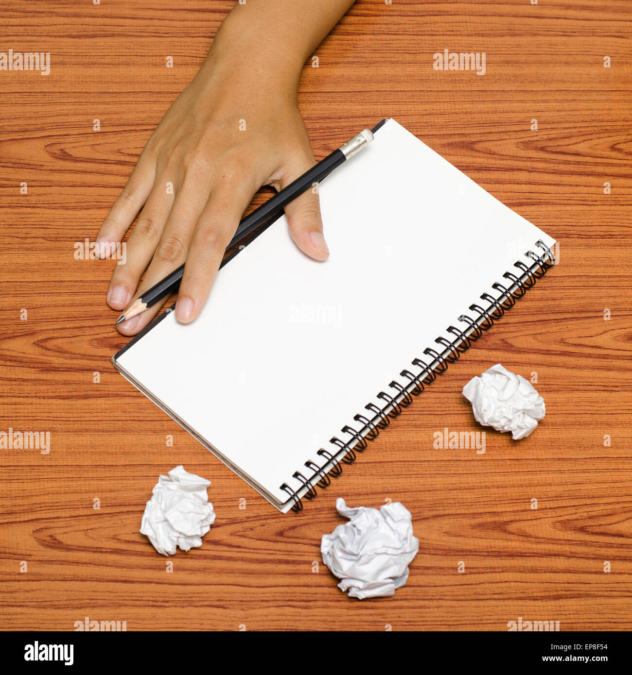 hand writing on notebook with crumpled paper on wood table background ...