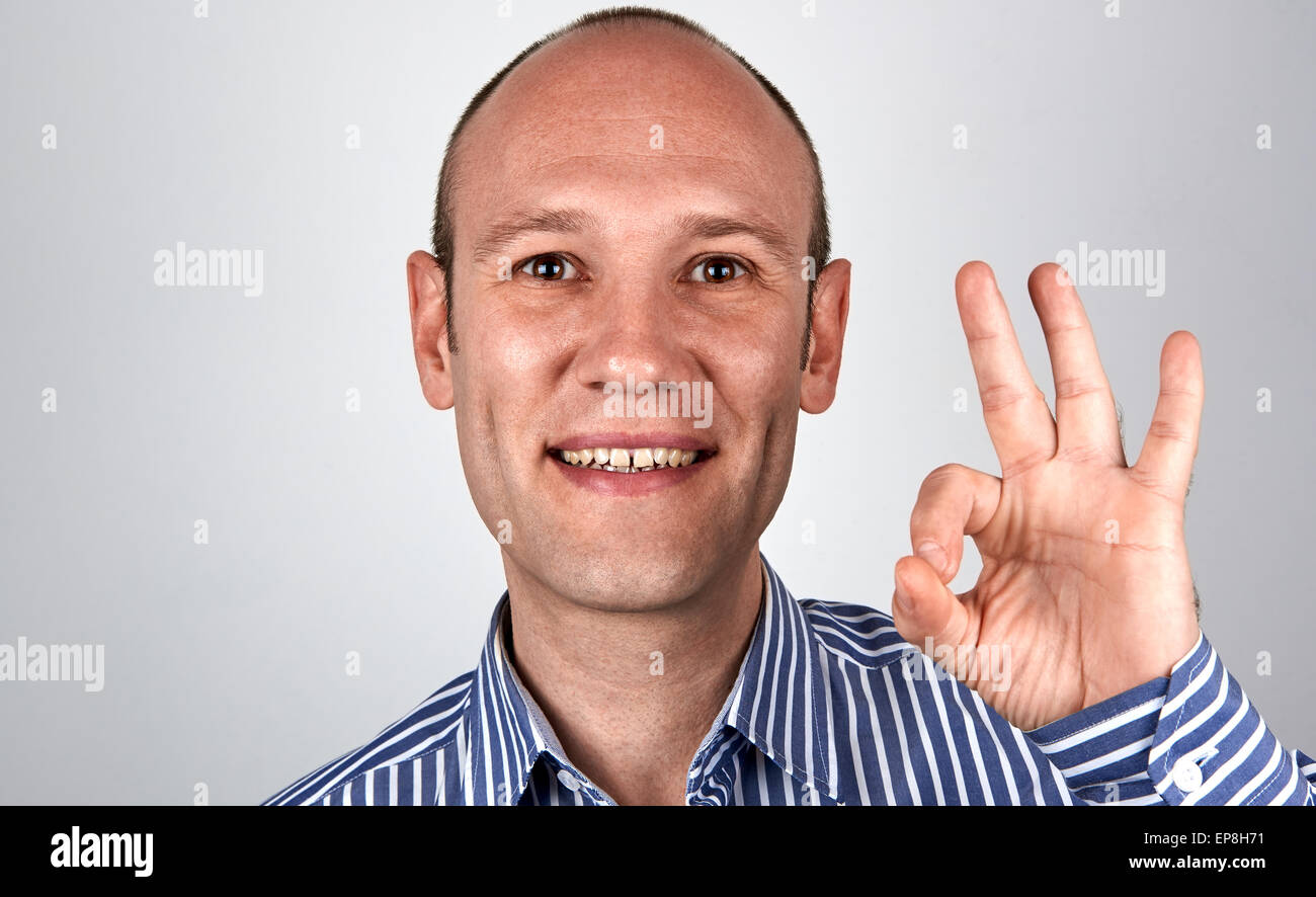 Man shows OK sign with positive emotion Stock Photo - Alamy