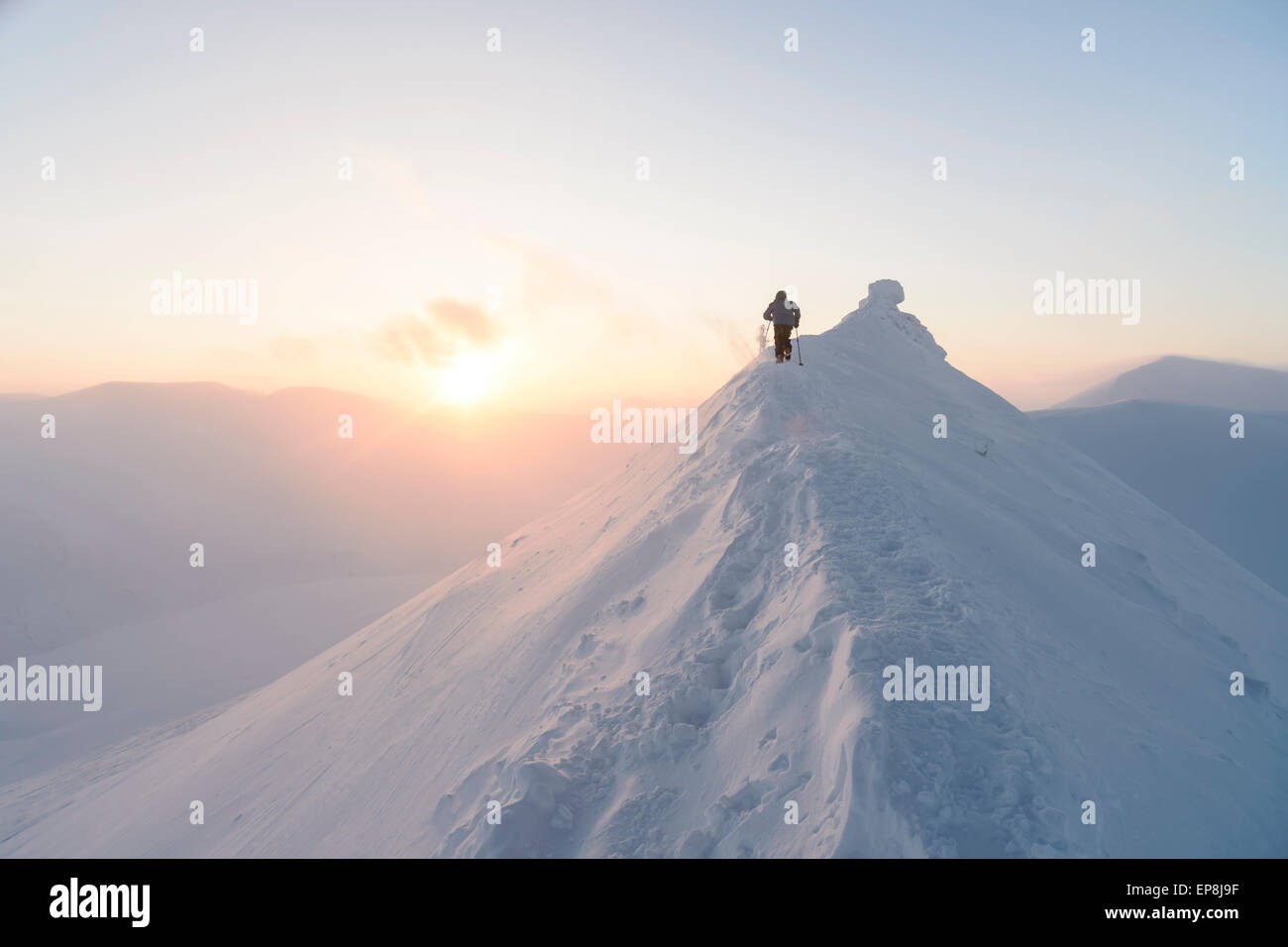Ski mountaineer on the Trollsteinen ridge in early morning light ...