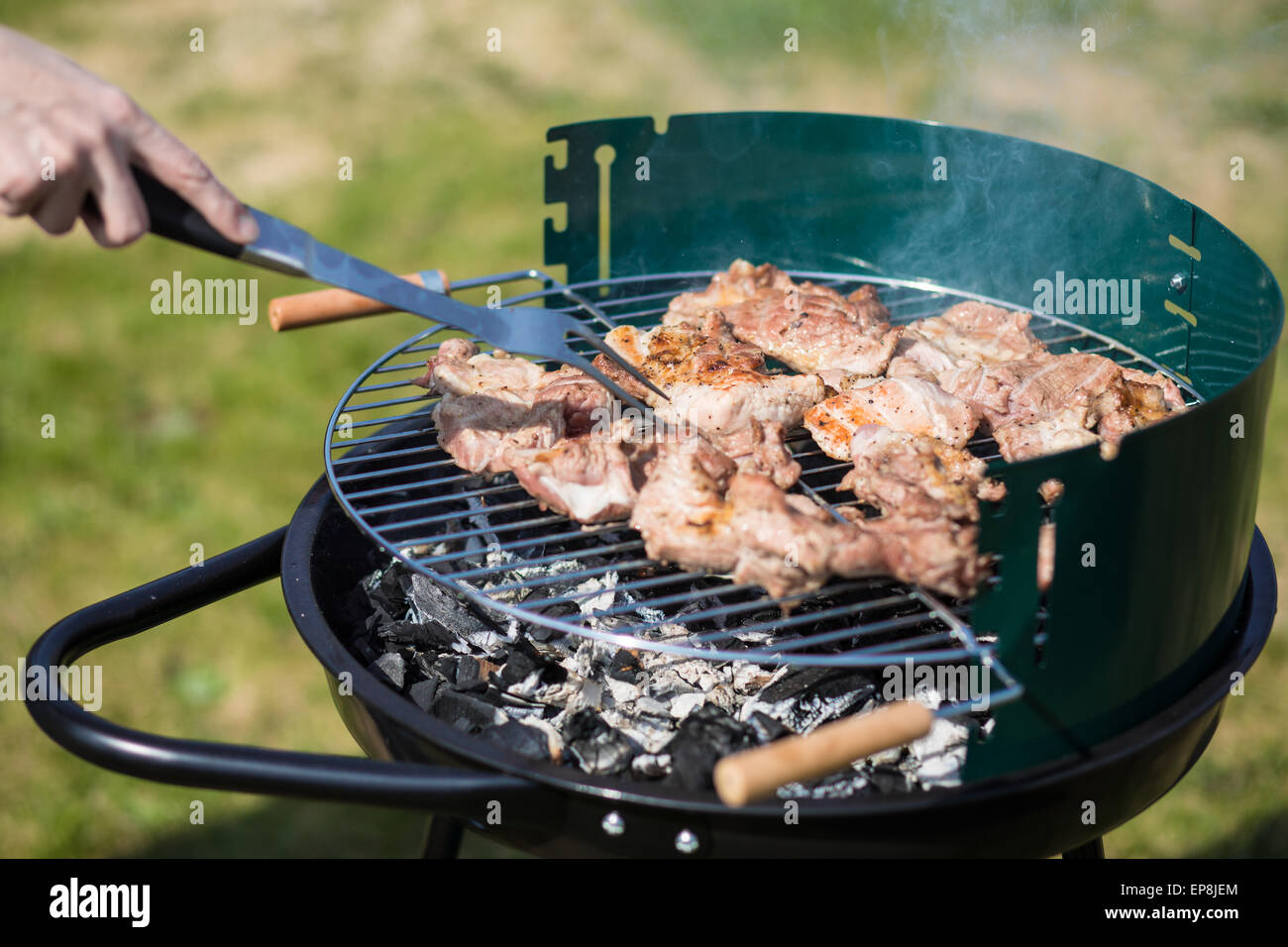bbq pork meat cooking outdoors on a portable grill Stock Photo - Alamy