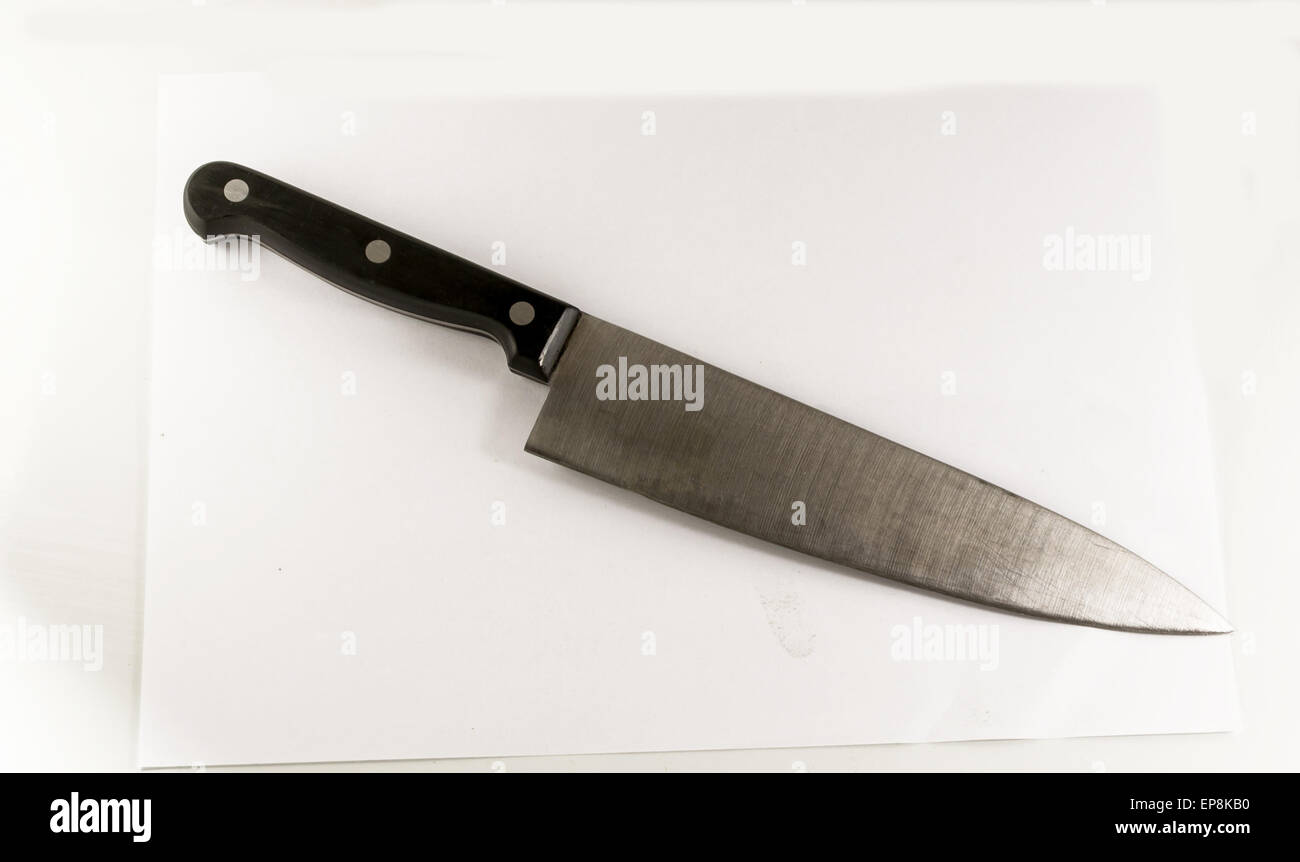 Well used sharp kitchen knife on a white background Stock Photo - Alamy