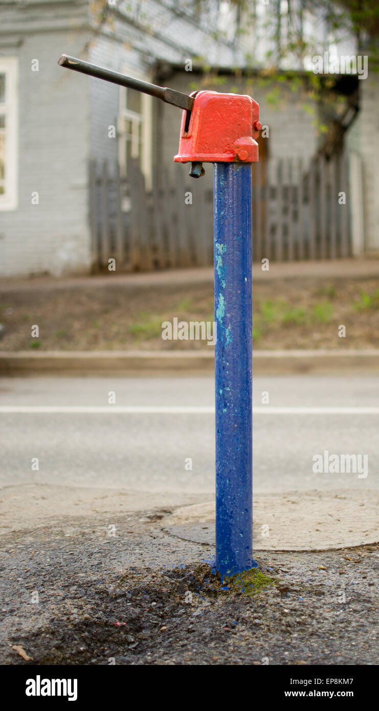 Blue and red traditional hand water pump common in Russia Stock Photo ...