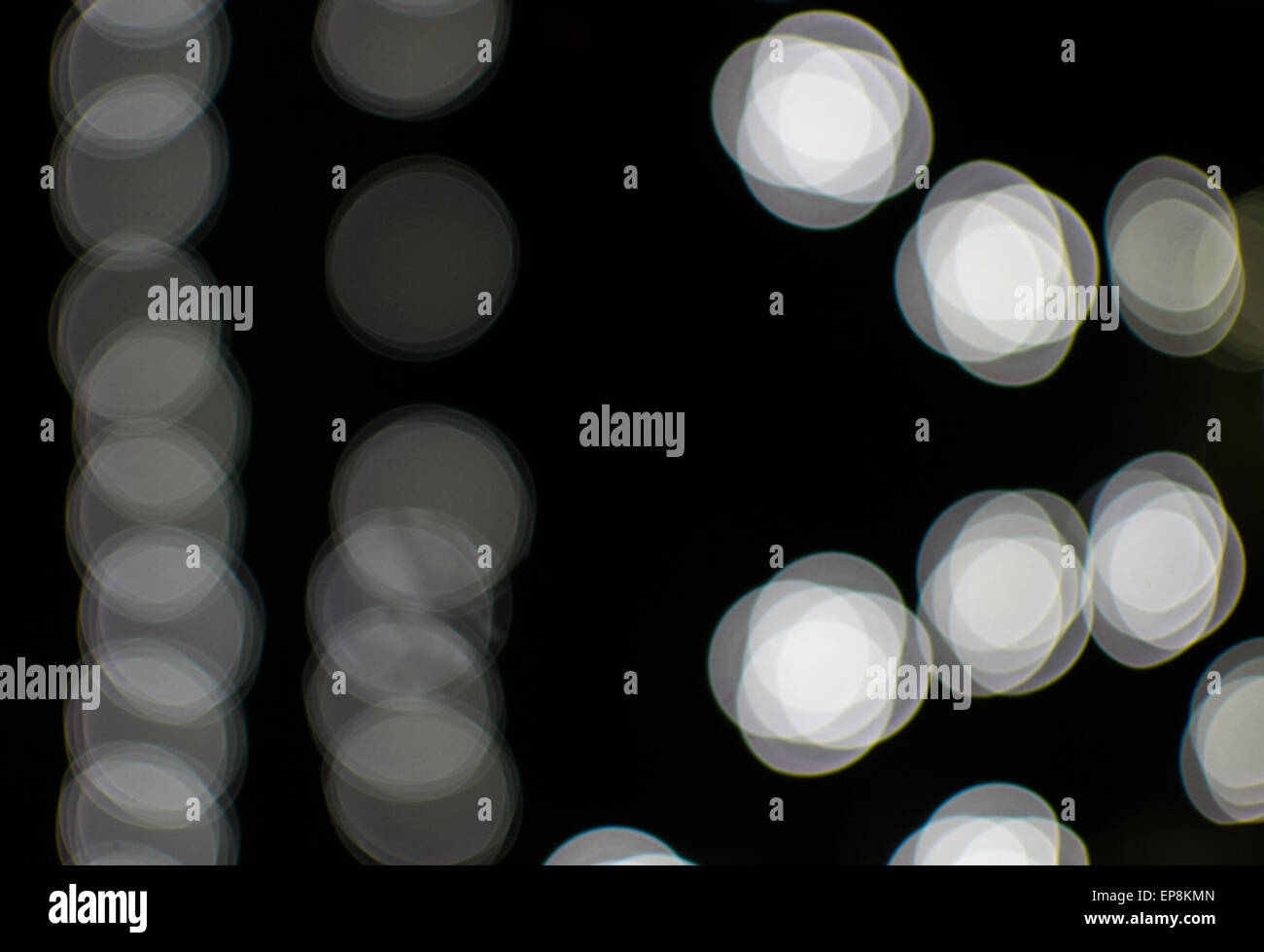 Fading white bokeh blurred light effect using a black background Stock ...