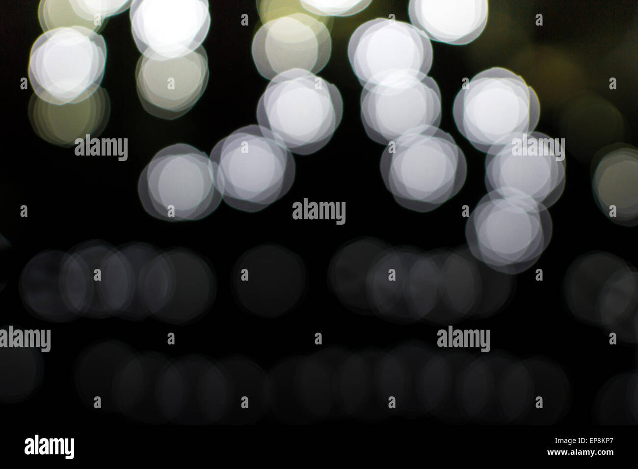 Fading white bokeh blurred light effect using a black background Stock ...