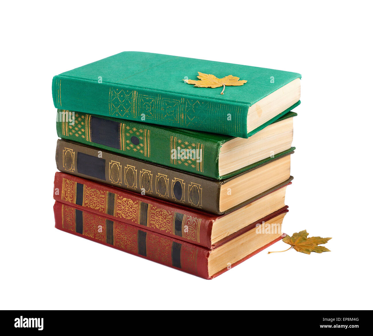 A stack of old books with gold stamping on a white background isolated ...