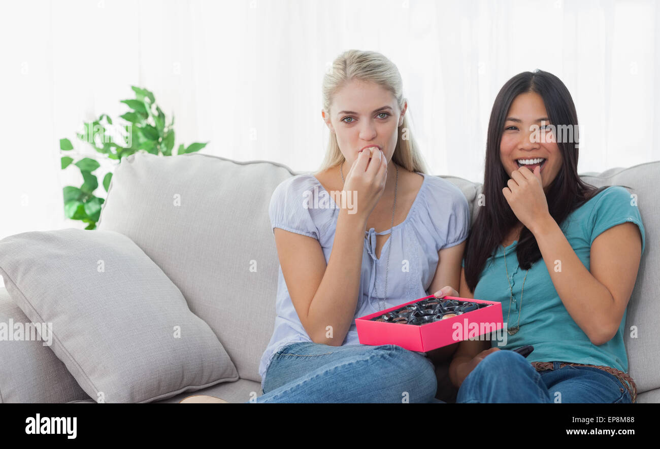 Friends smiling and sharing box of chocolates Stock Photo - Alamy