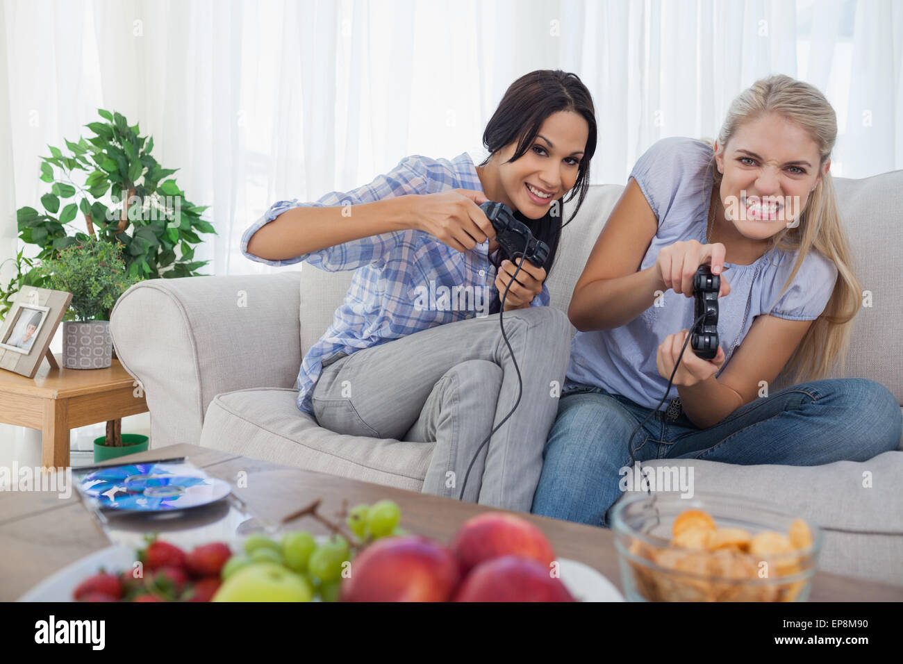 Competitive friends playing video games and having fun Stock Photo - Alamy