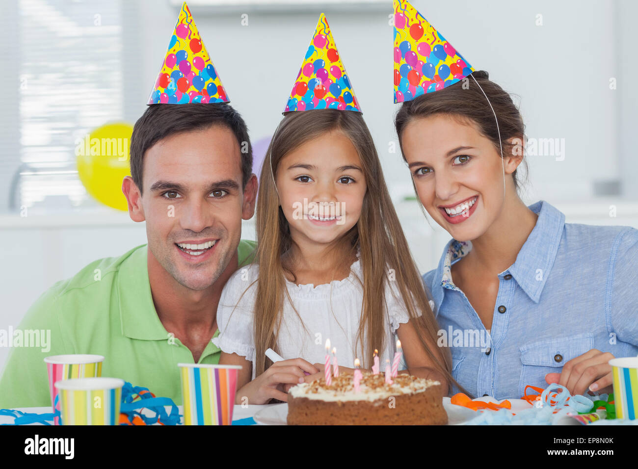 Parents celebrating their little girls birthday Stock Photo - Alamy