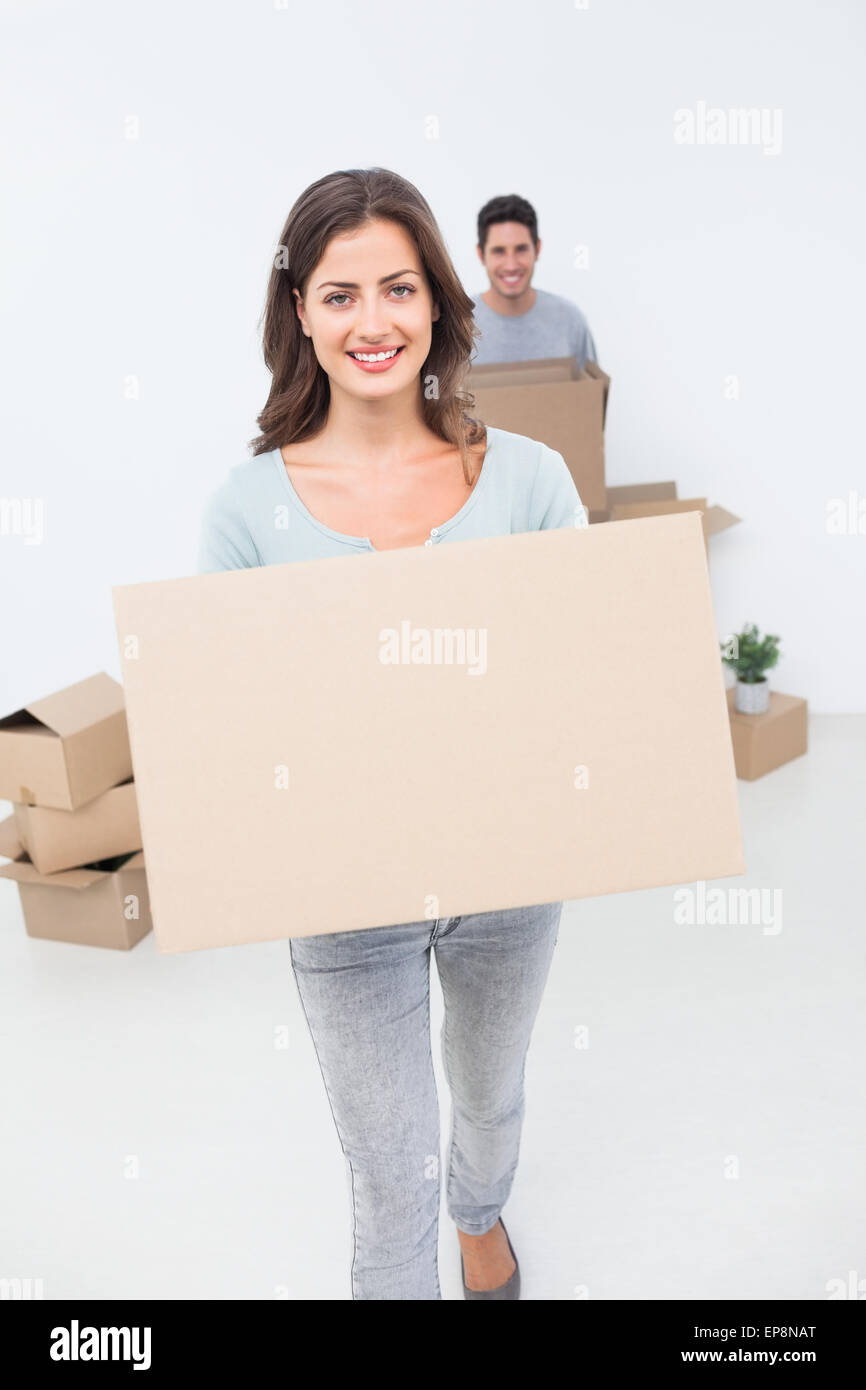Attractive woman holding boxes in her new house Stock Photo - Alamy