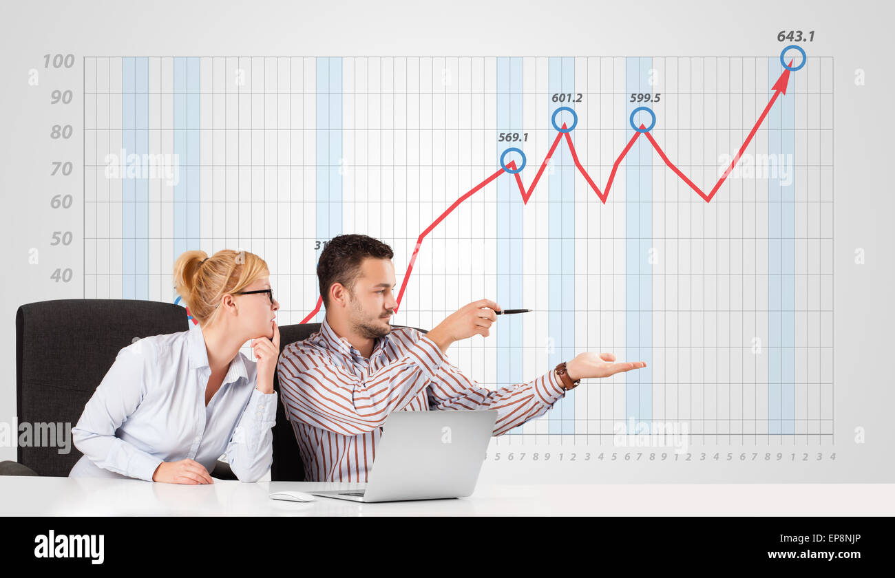 Businessman and businesswoman calculating stock market with rising ...