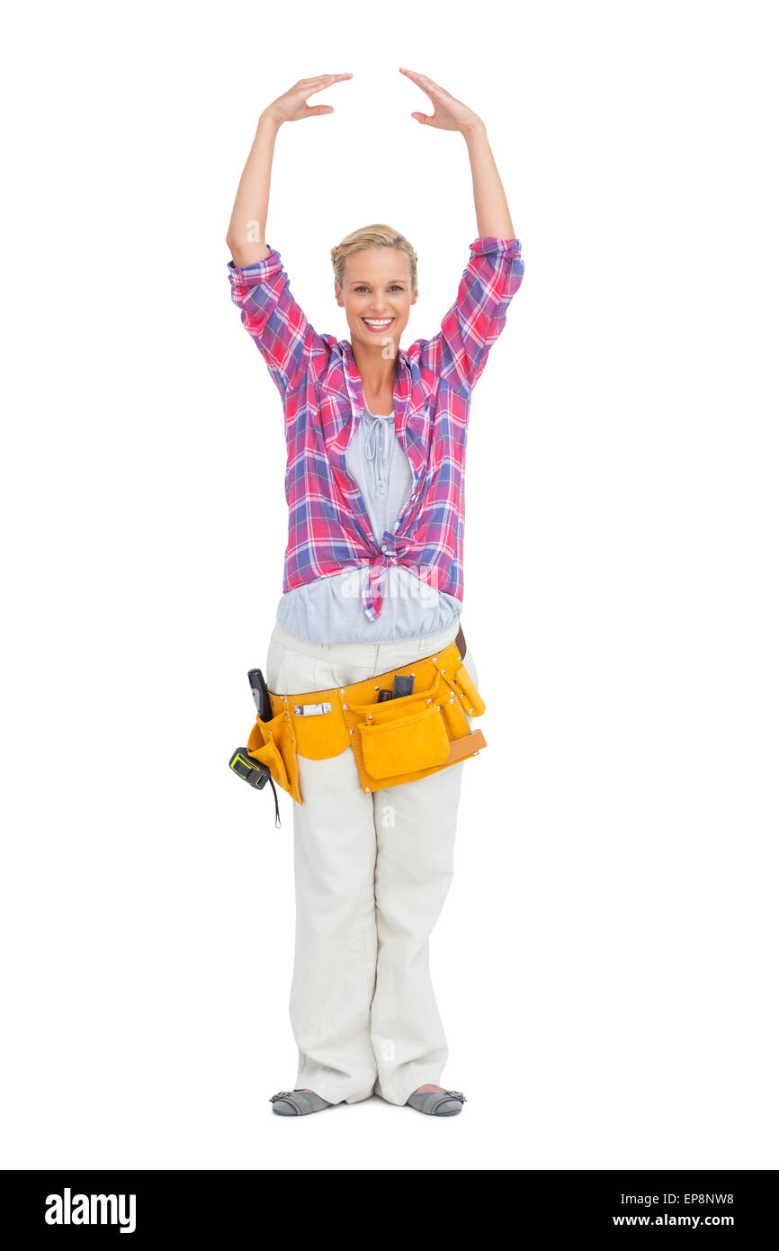 Pretty blonde wearing a tool belt in ballerina pose Stock Photo - Alamy