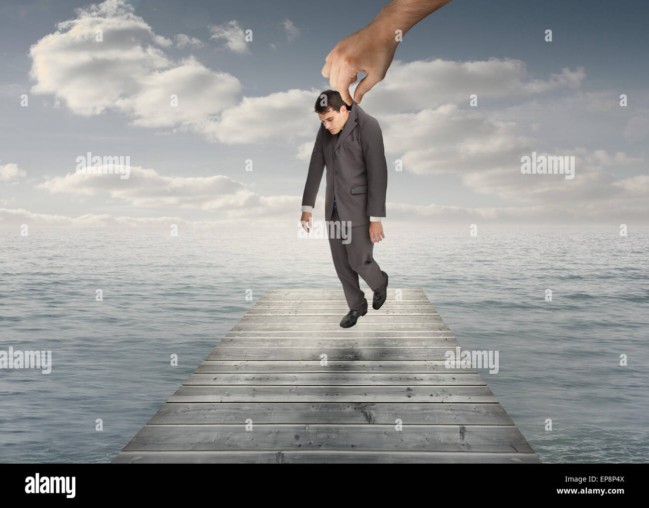 Giant hand holding a businessman by his jacket Stock Photo - Alamy
