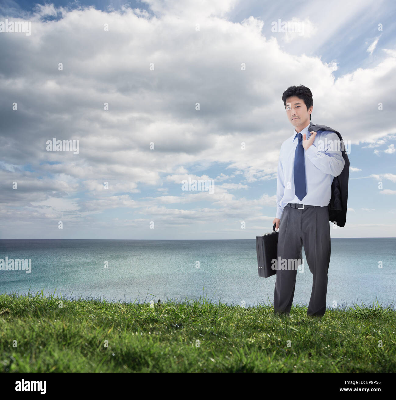 Elegant businessman holding briefcase and his jacket over his shoulder ...