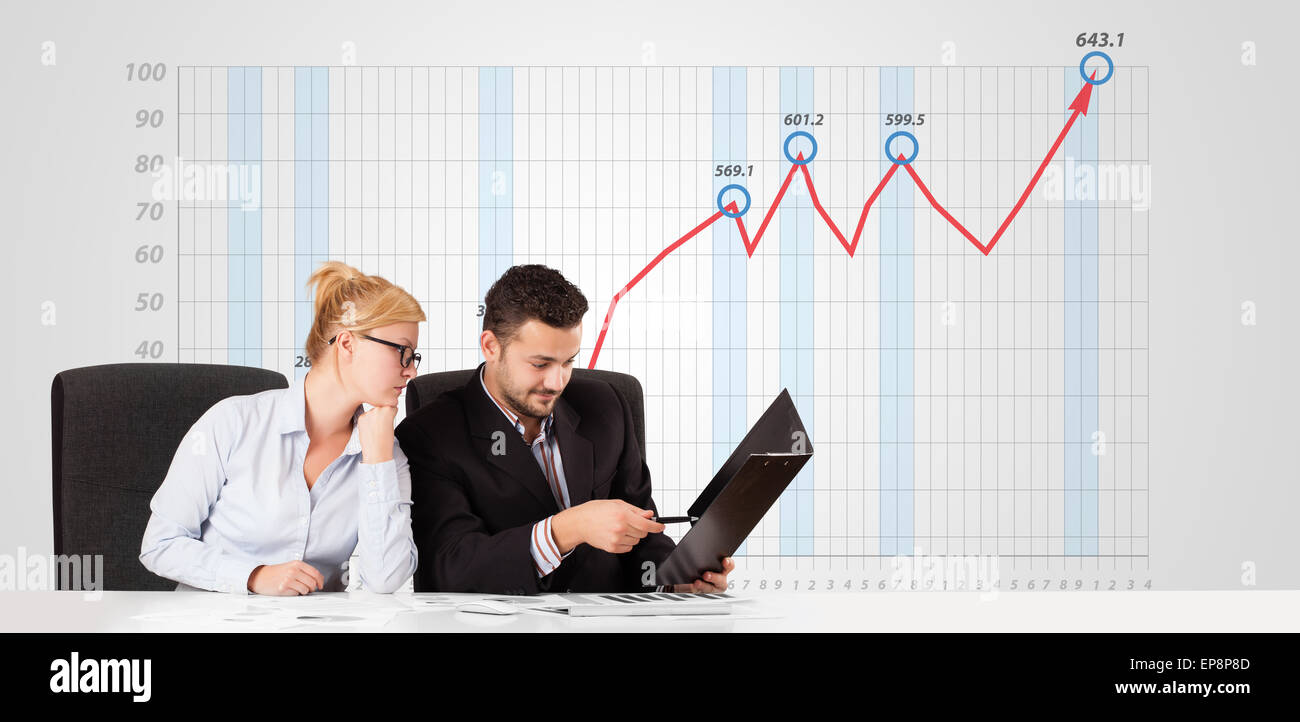 Businessman and businesswoman calculating stock market with rising ...