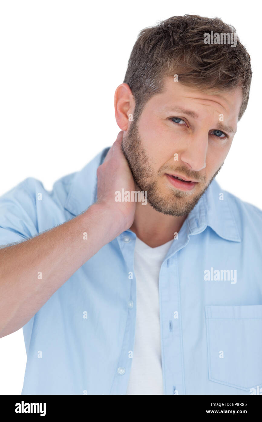 Trendy model having a painful neck and looking at camera Stock Photo ...