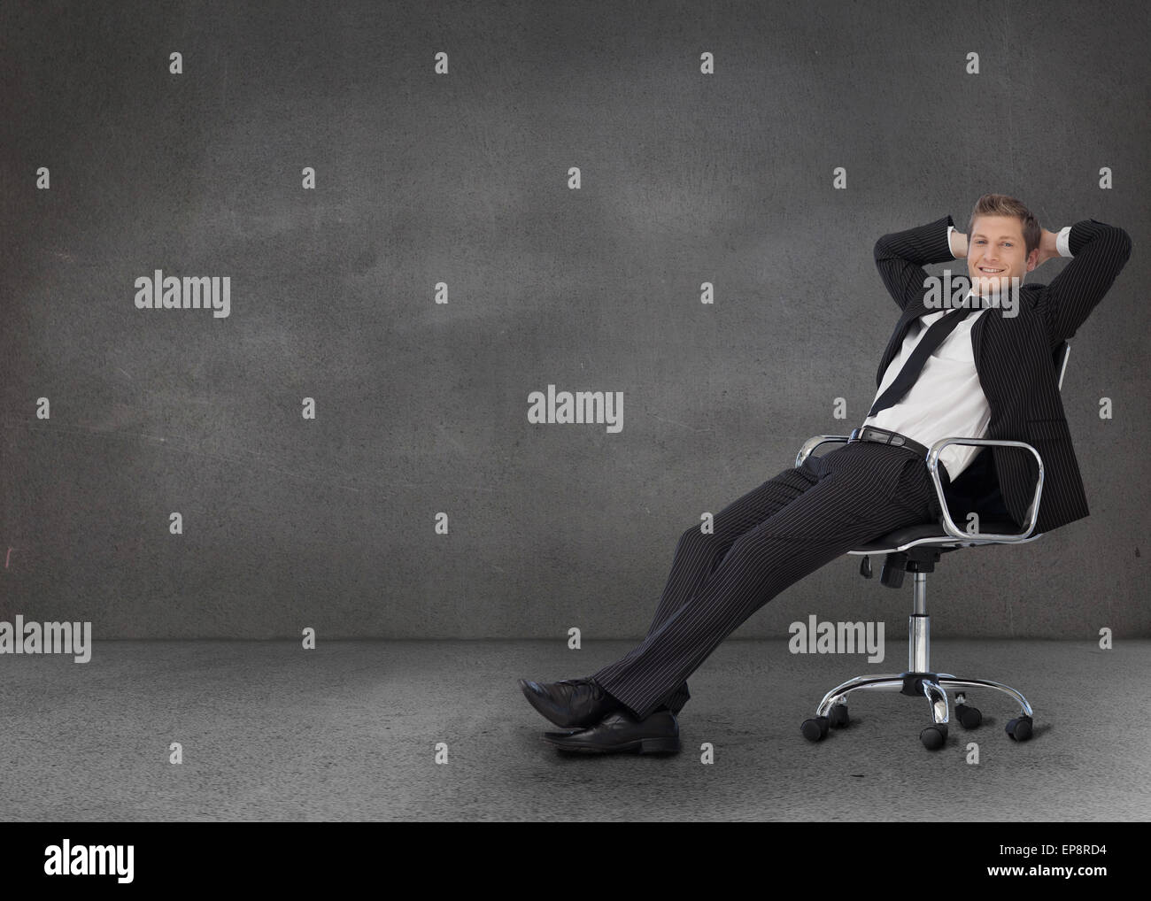 Handsome businessman resting in his swivel chair Stock Photo - Alamy