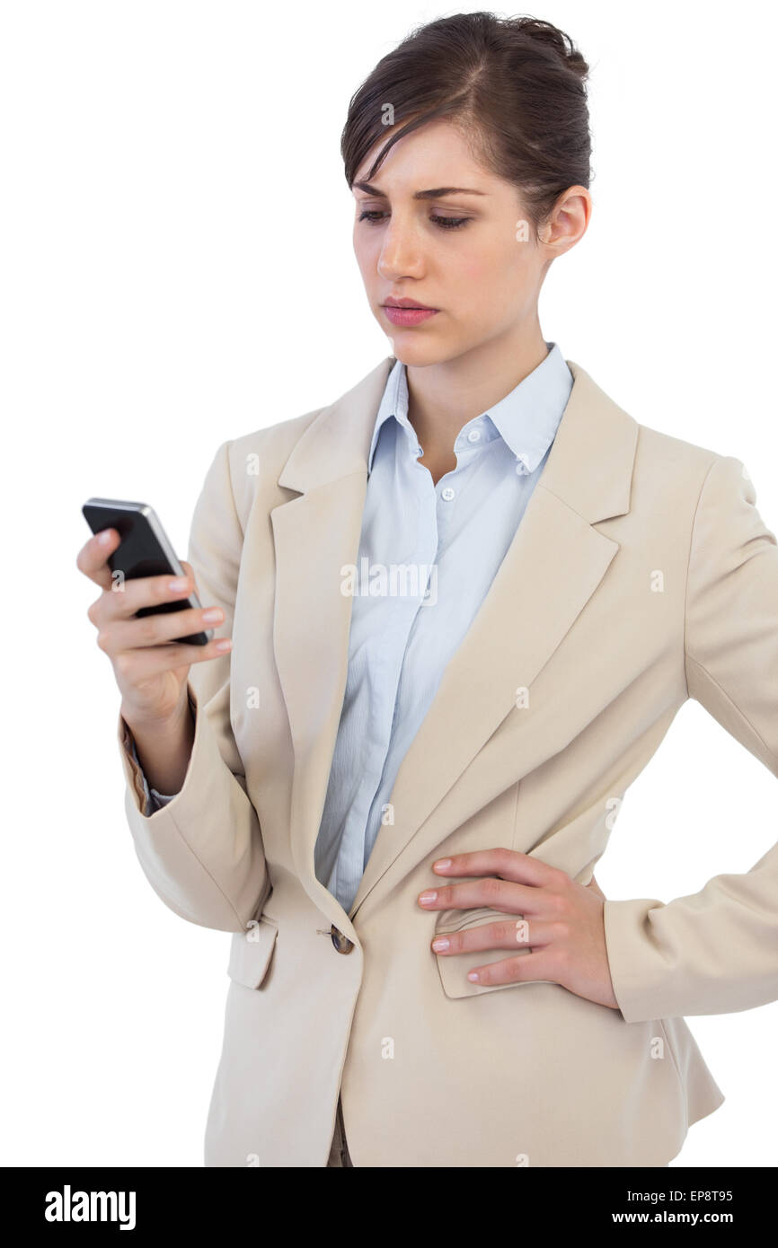 Serious businesswoman posing with phone on right hand Stock Photo - Alamy