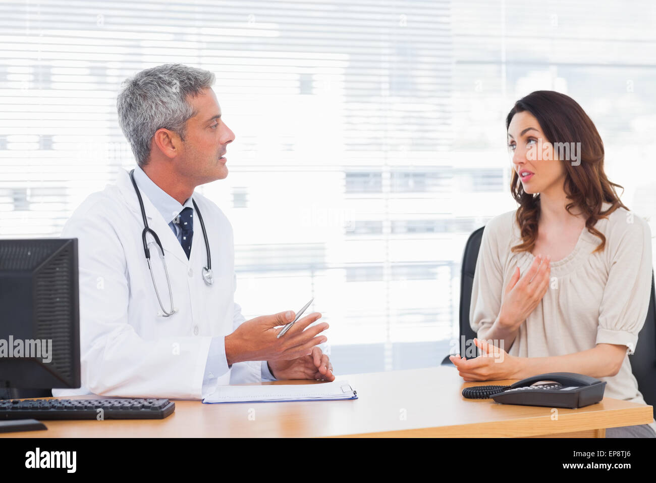 Female doctor telling patient hi-res stock photography and images - Alamy