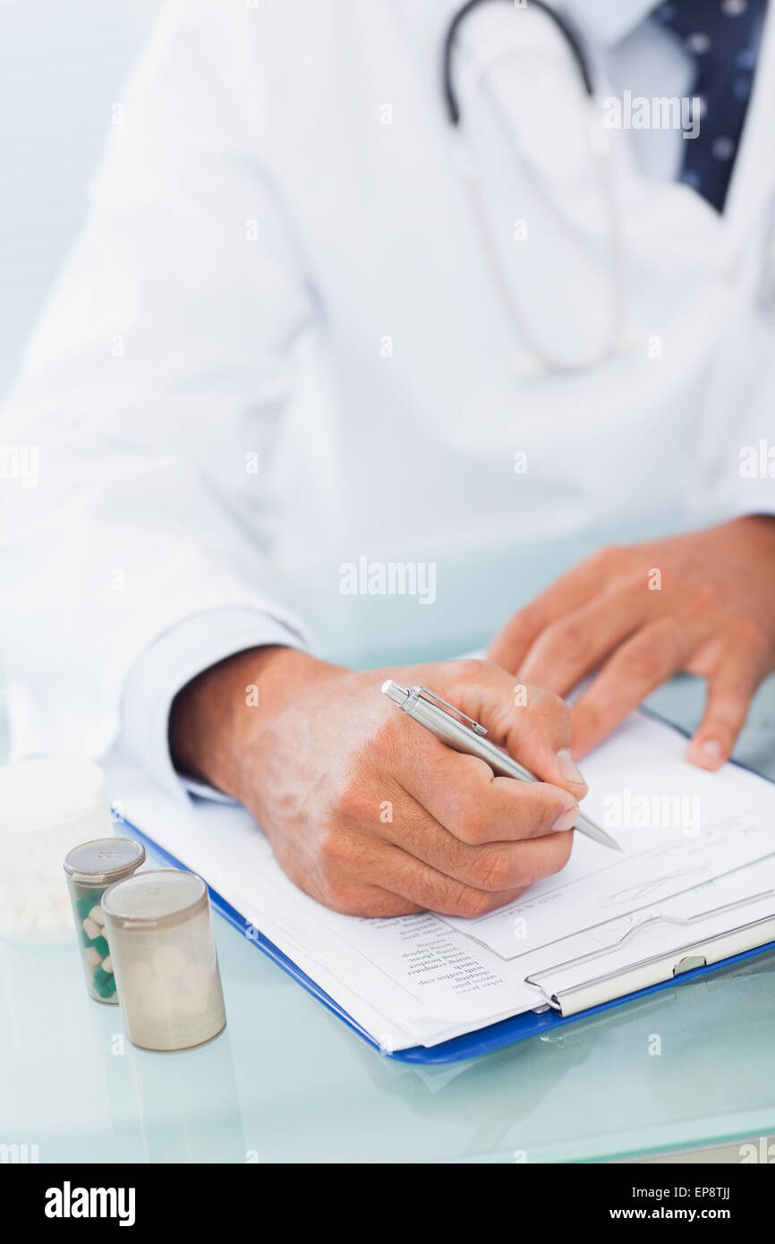 Doctor writing prescription desk close hi-res stock photography and ...